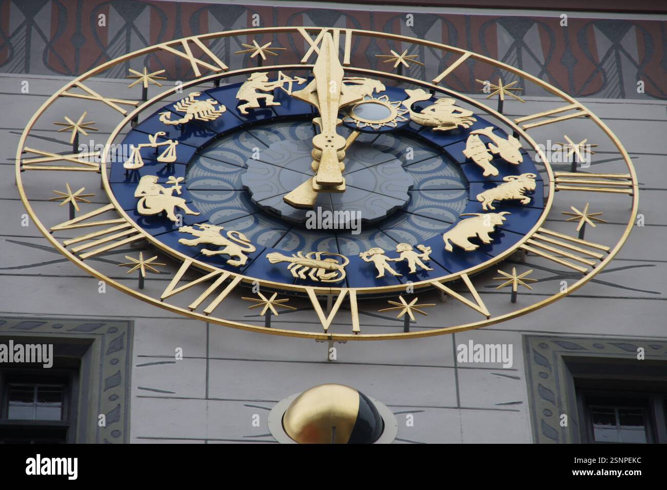 An ornately decorated clock face in Munich, Germany, features the ...