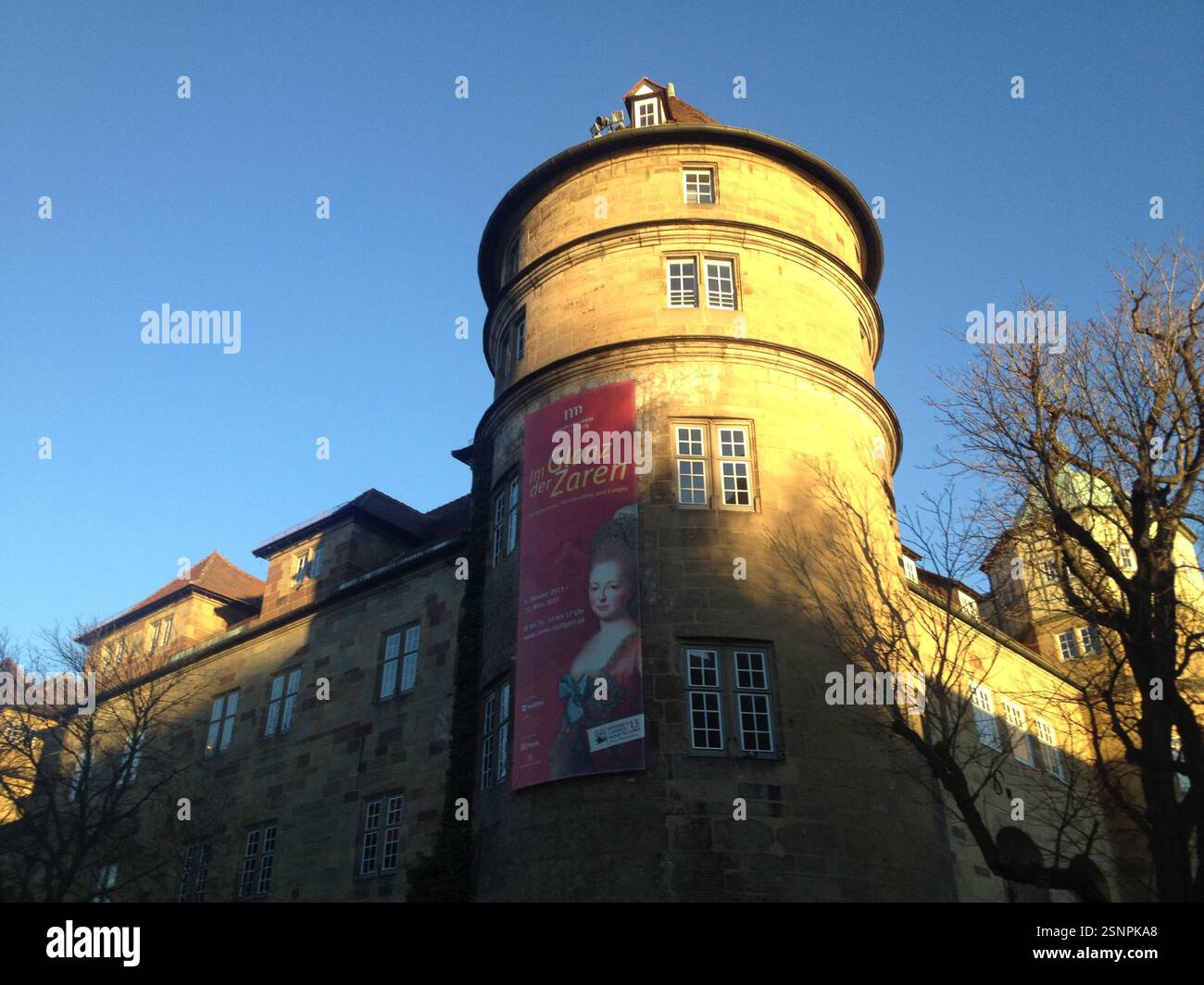 Majestic old castle with a towering structure and fluttering banner ...
