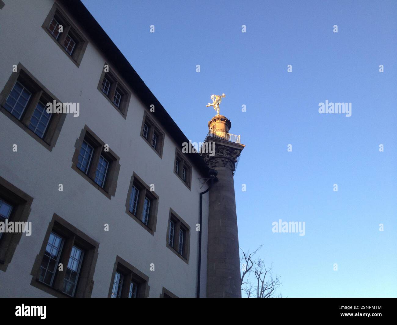 Tall column with a statue, Germany, Munich. Clear blue sky backdrop ...