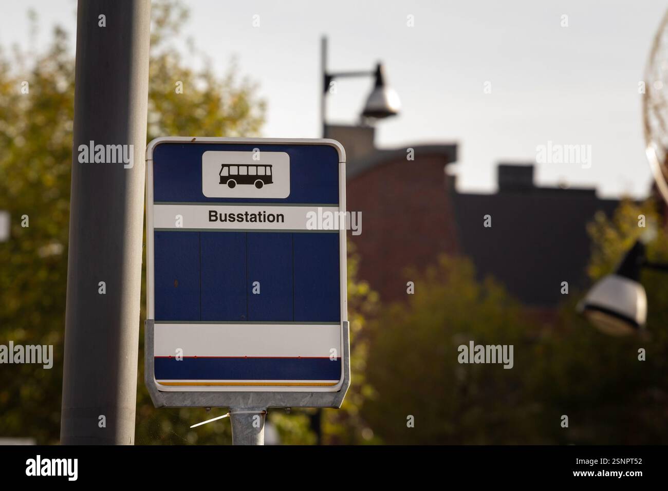 A public bus station sign in the Netherlands displays clear, bold ...