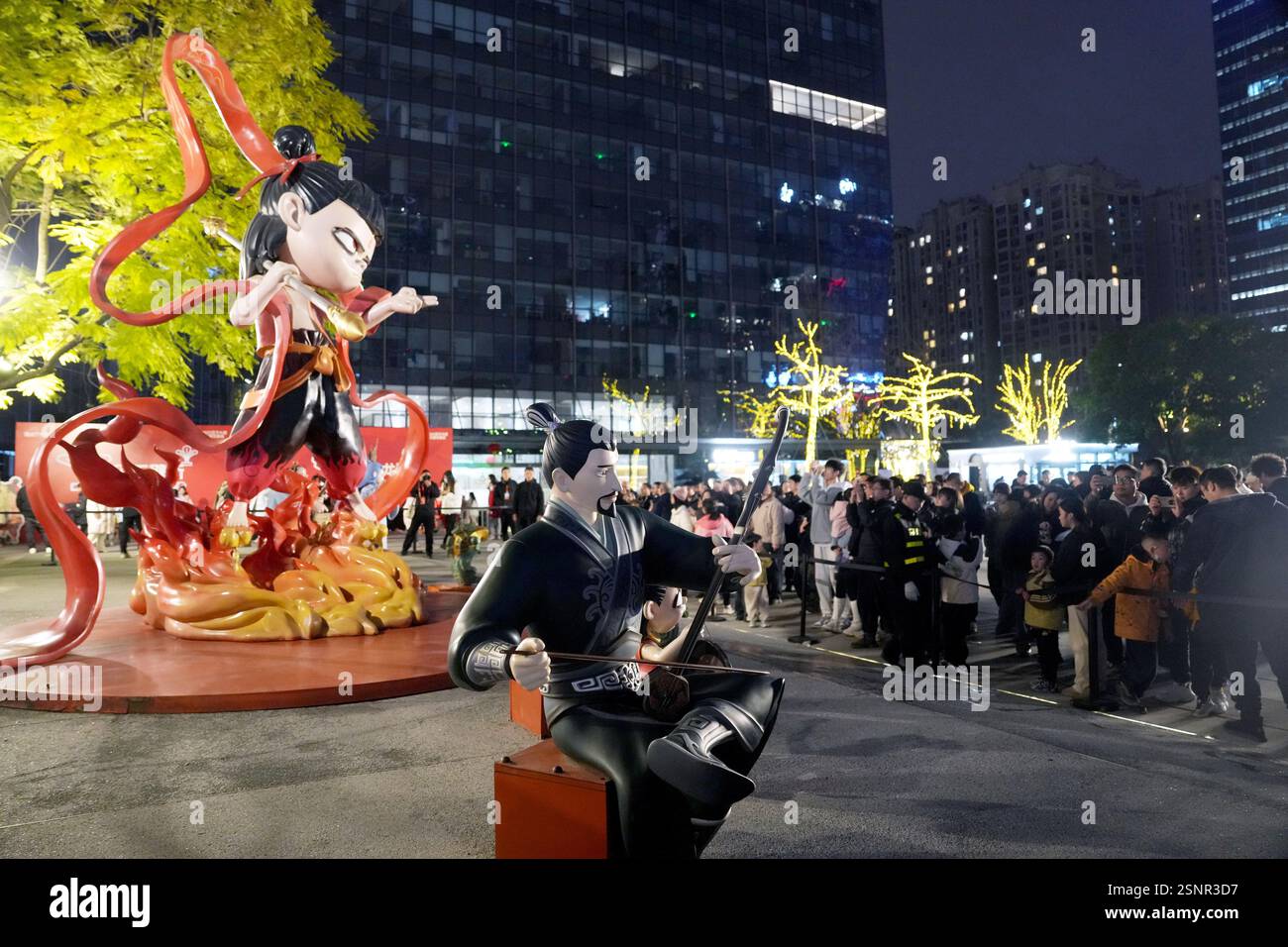 Chengdu,China.12th February 2025. People pose for photos with a ...
