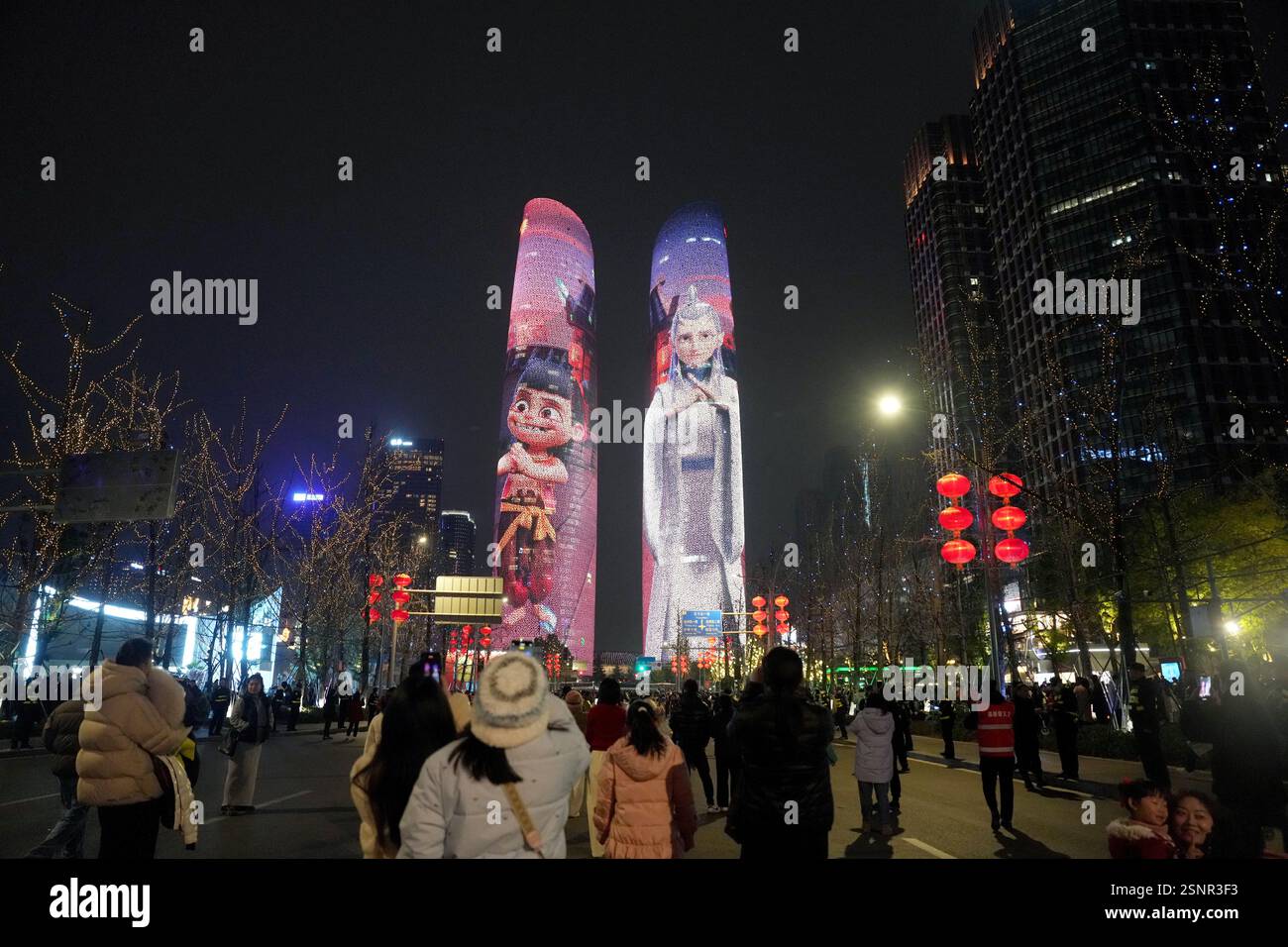 Chengdu,China.12th February 2025. The twin towers are illuminated with ...