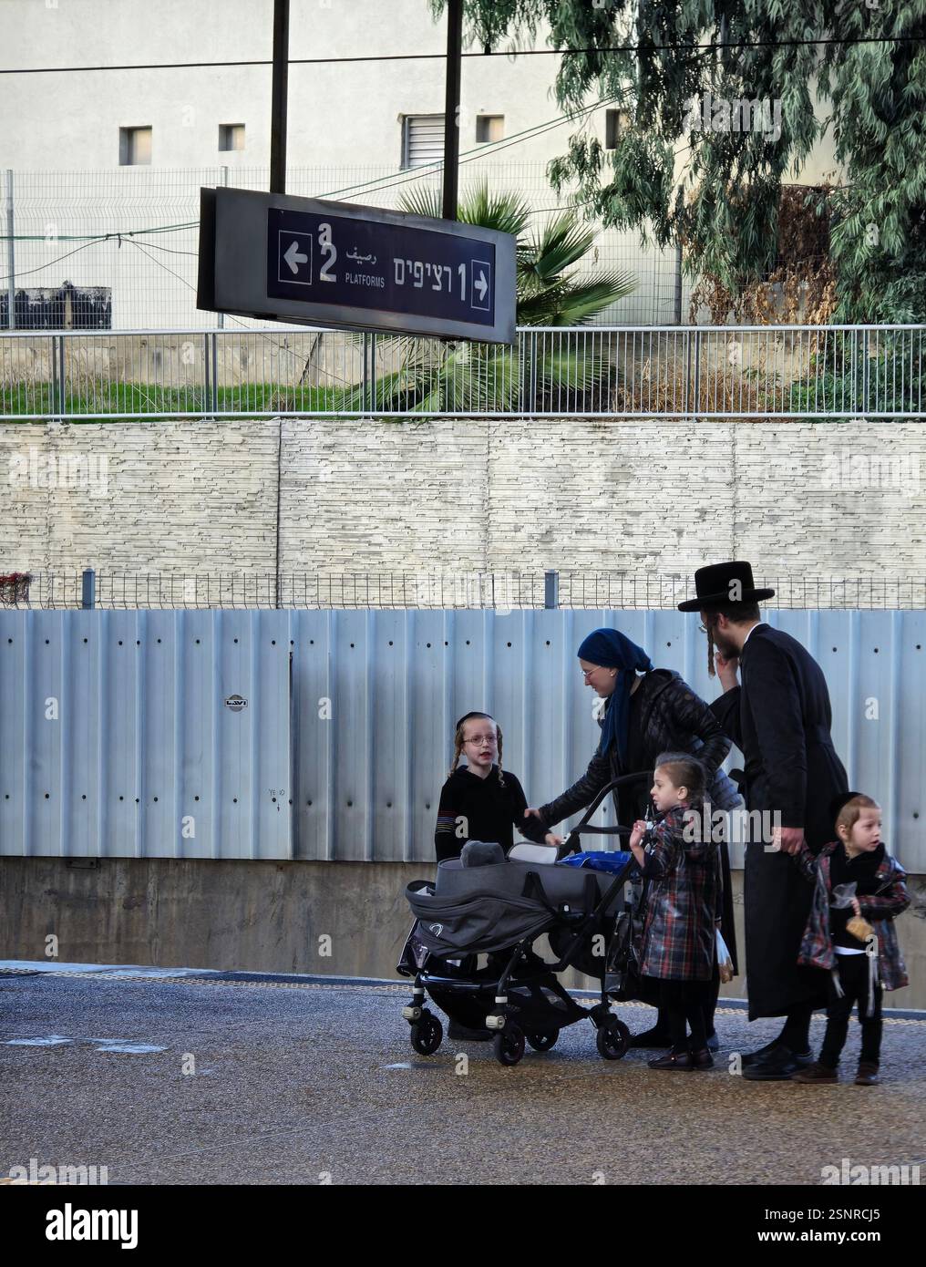 A religious Haredim Jewish family waiting for the train at the Savidor ...