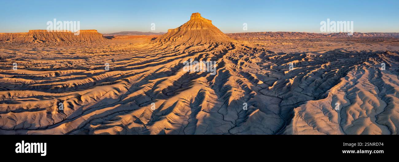 Aerial panoramic view of Factory Butte at sunrise featuring the ...