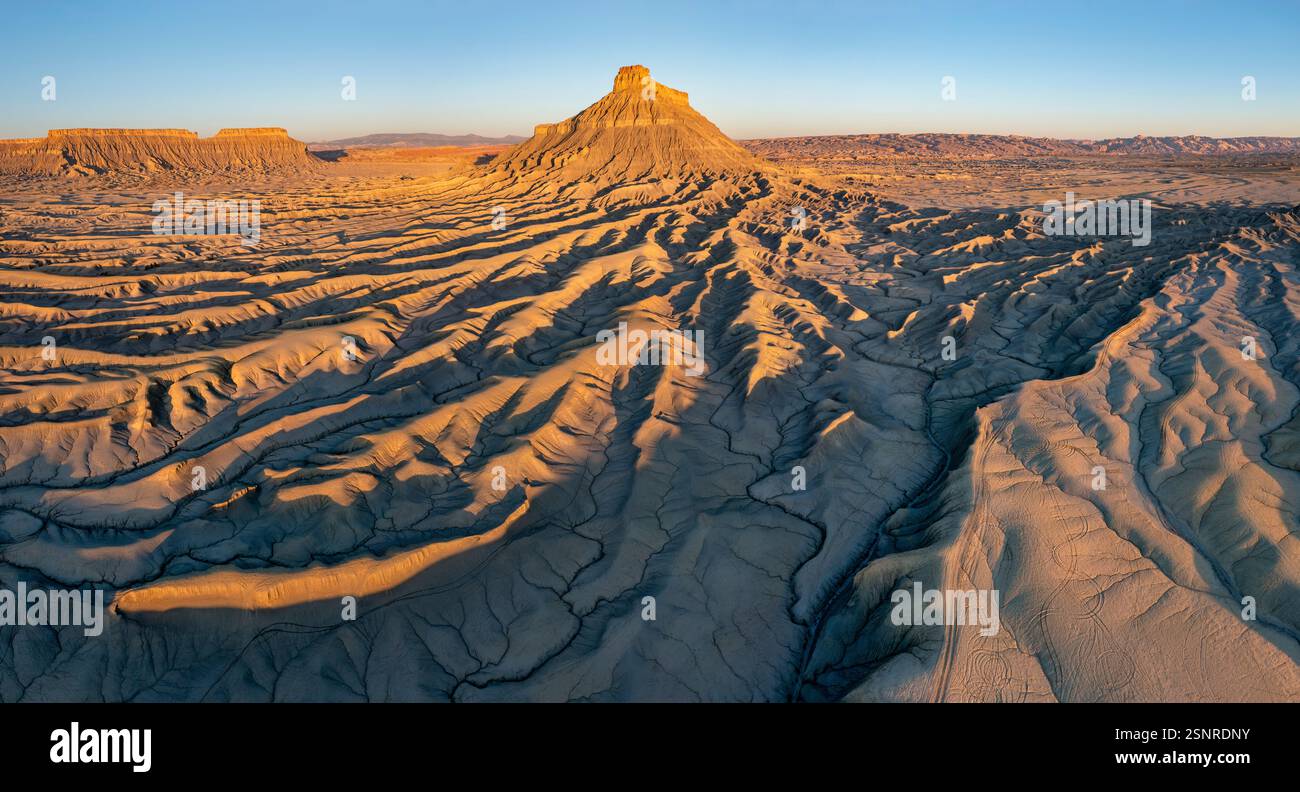 Aerial panoramic view of Factory Butte at sunrise featuring the ...