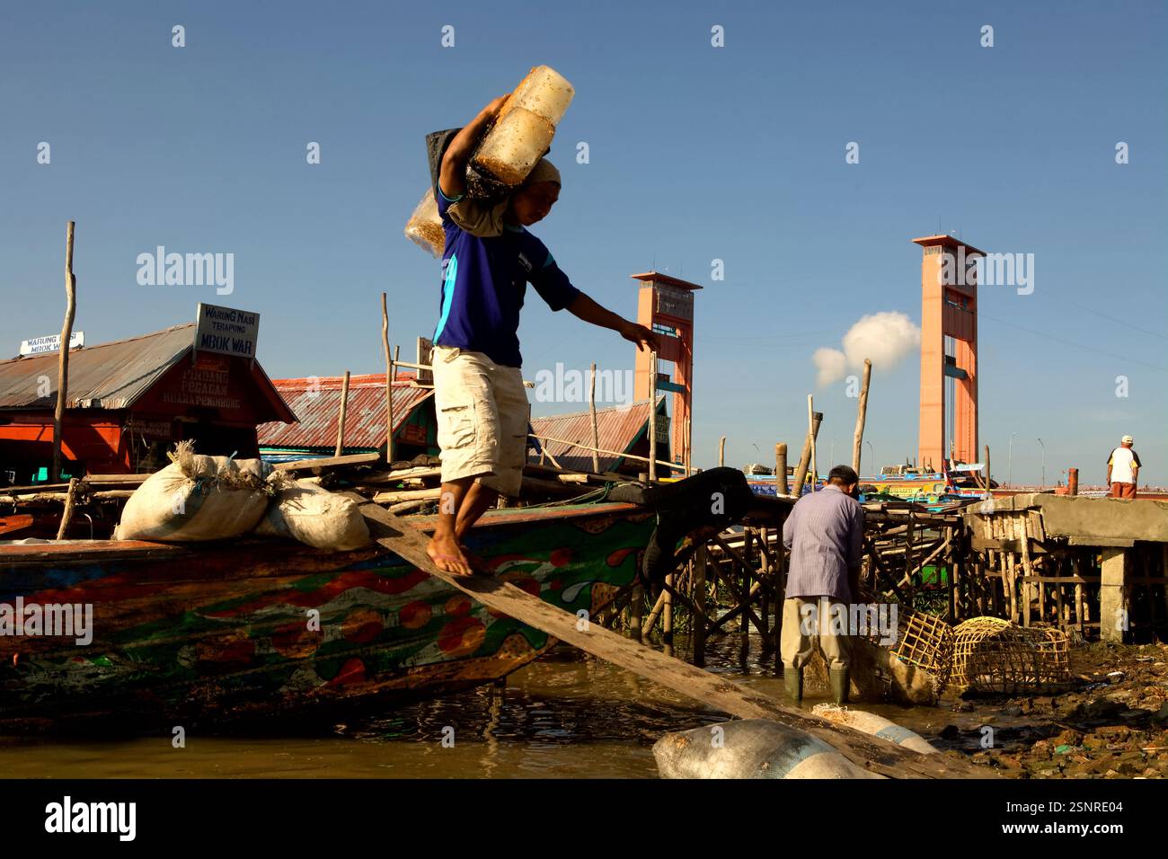 People's activities are photographed on Musi riverbank, in a background ...
