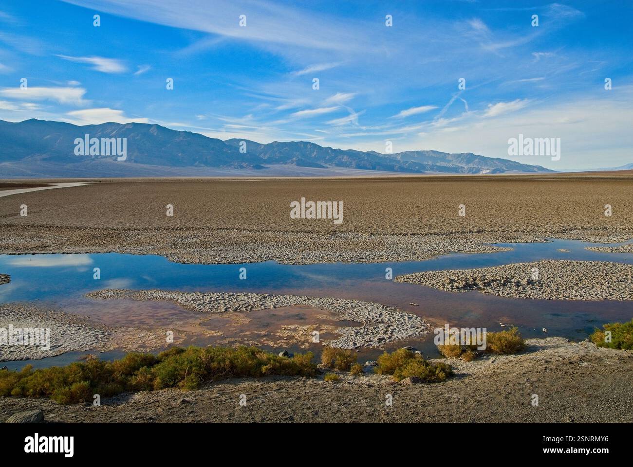 Panoramic view of Badwater Basin salt flats with cirrus cloud ...