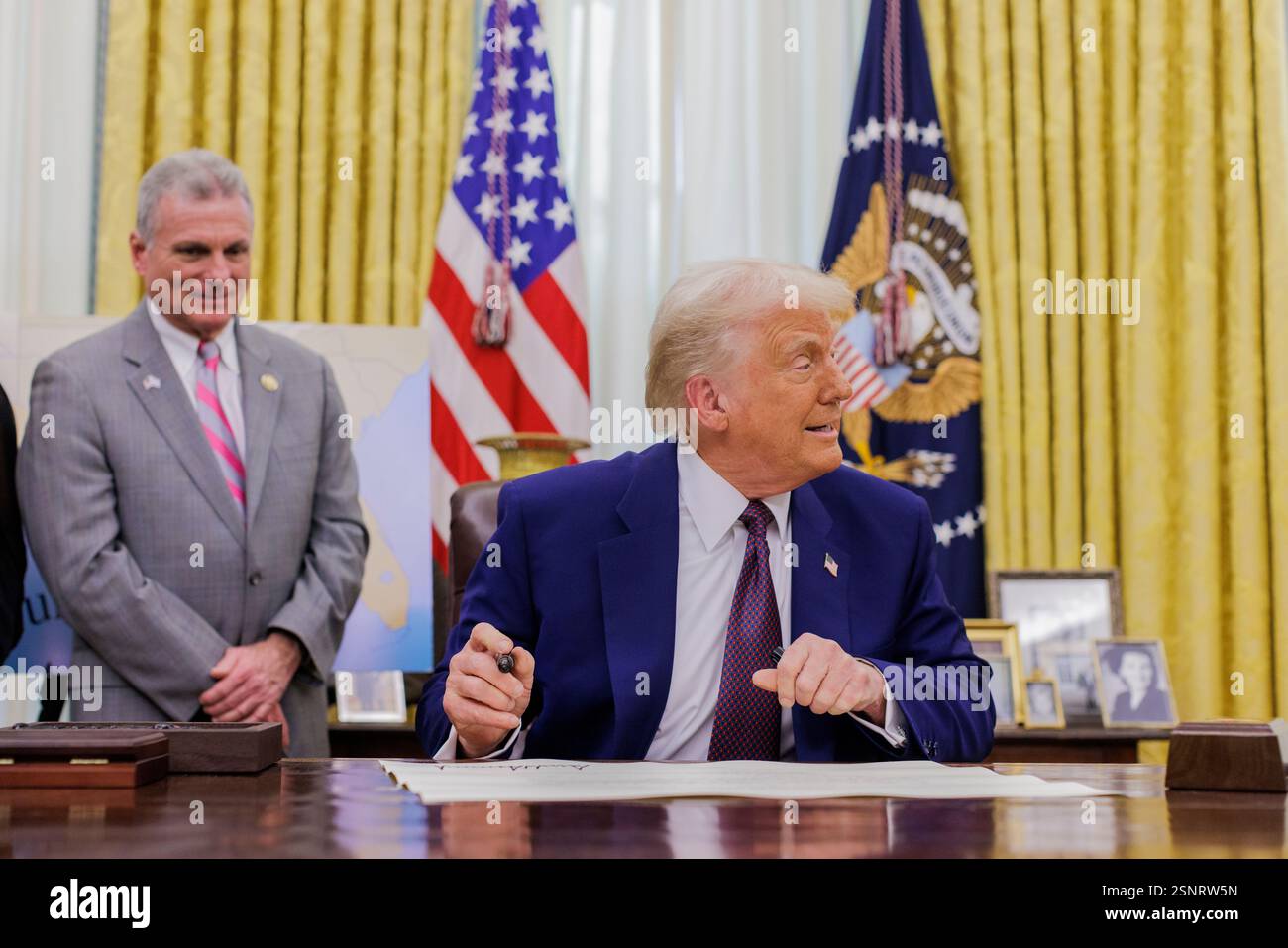 United States President Donald Trump signs the commissioning document ...
