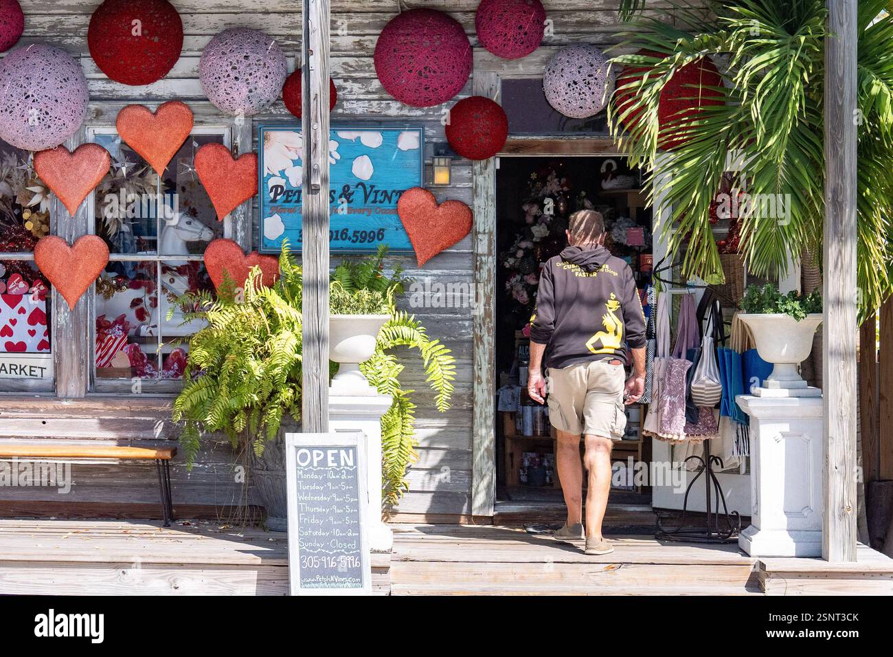 Key West, United States. 13th Feb, 2025. A man enters a flower shop ...