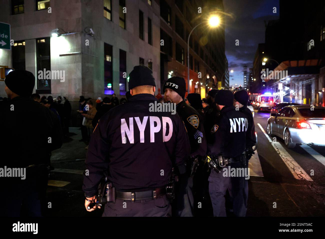Police officers stand as demonstrators against immigrant deportations ...
