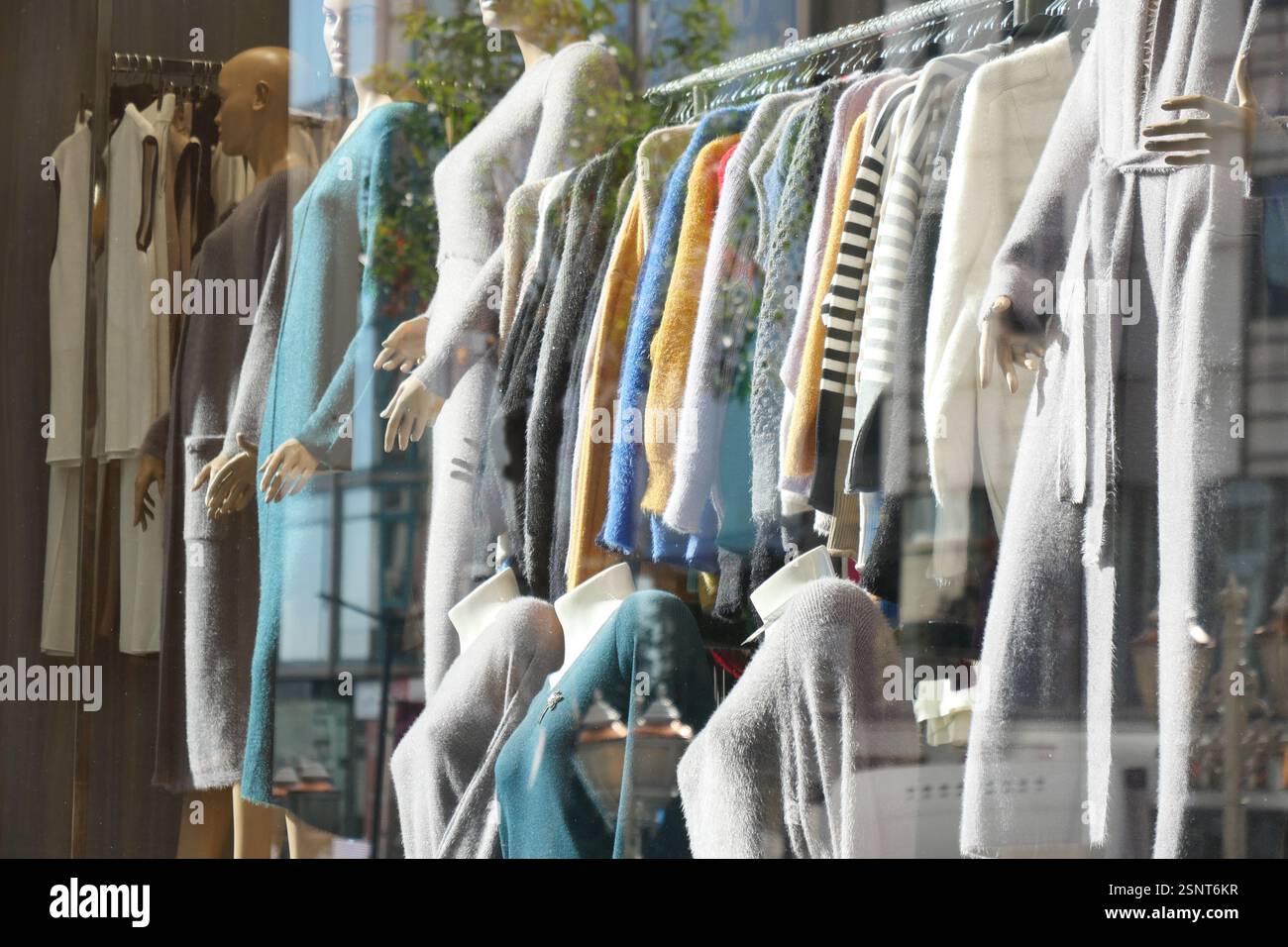 Fashion display showcases colorful garments in a storefront Stock Photo ...