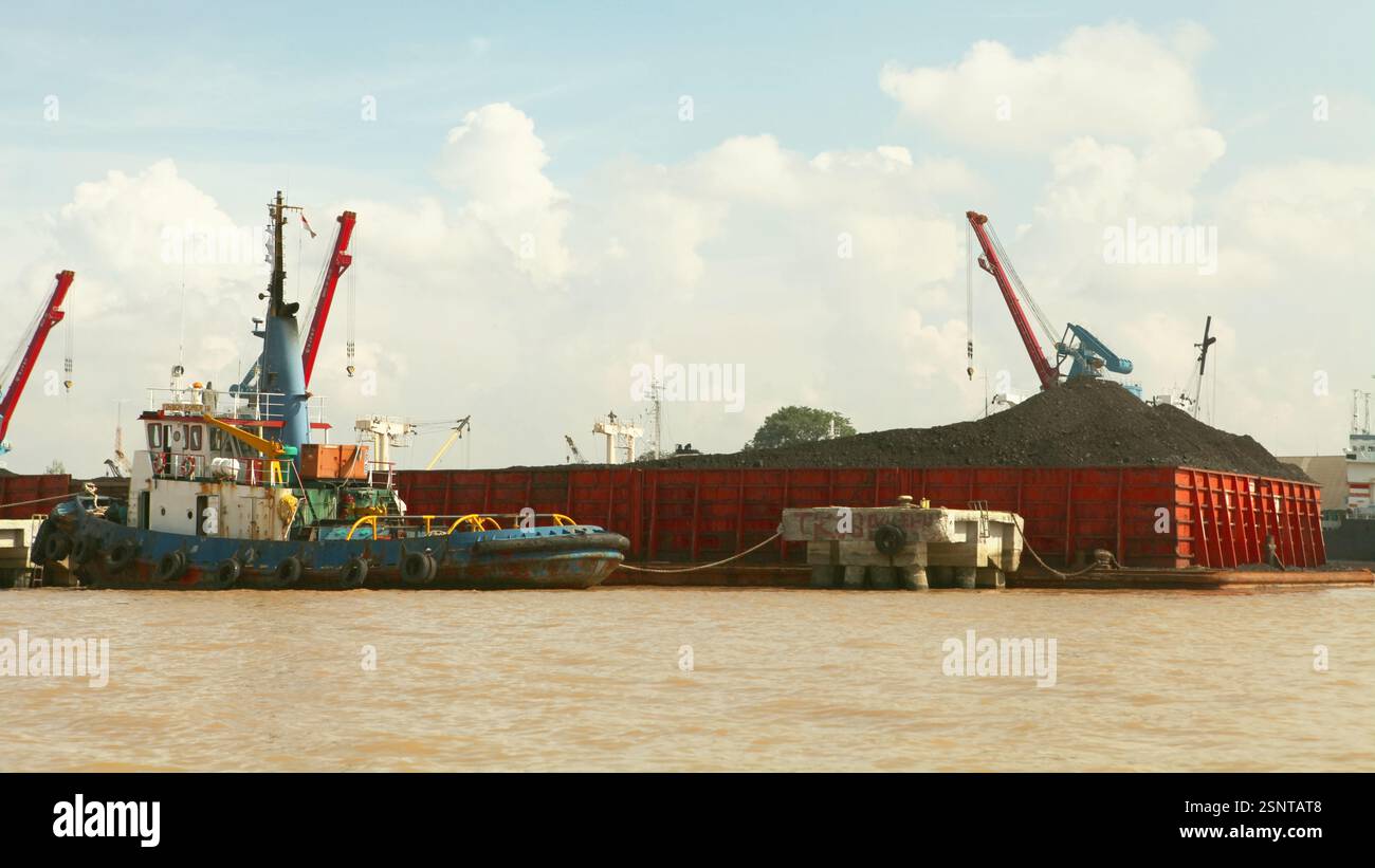 A shipping port for coal on river Musi in Palembang, South Sumatra ...