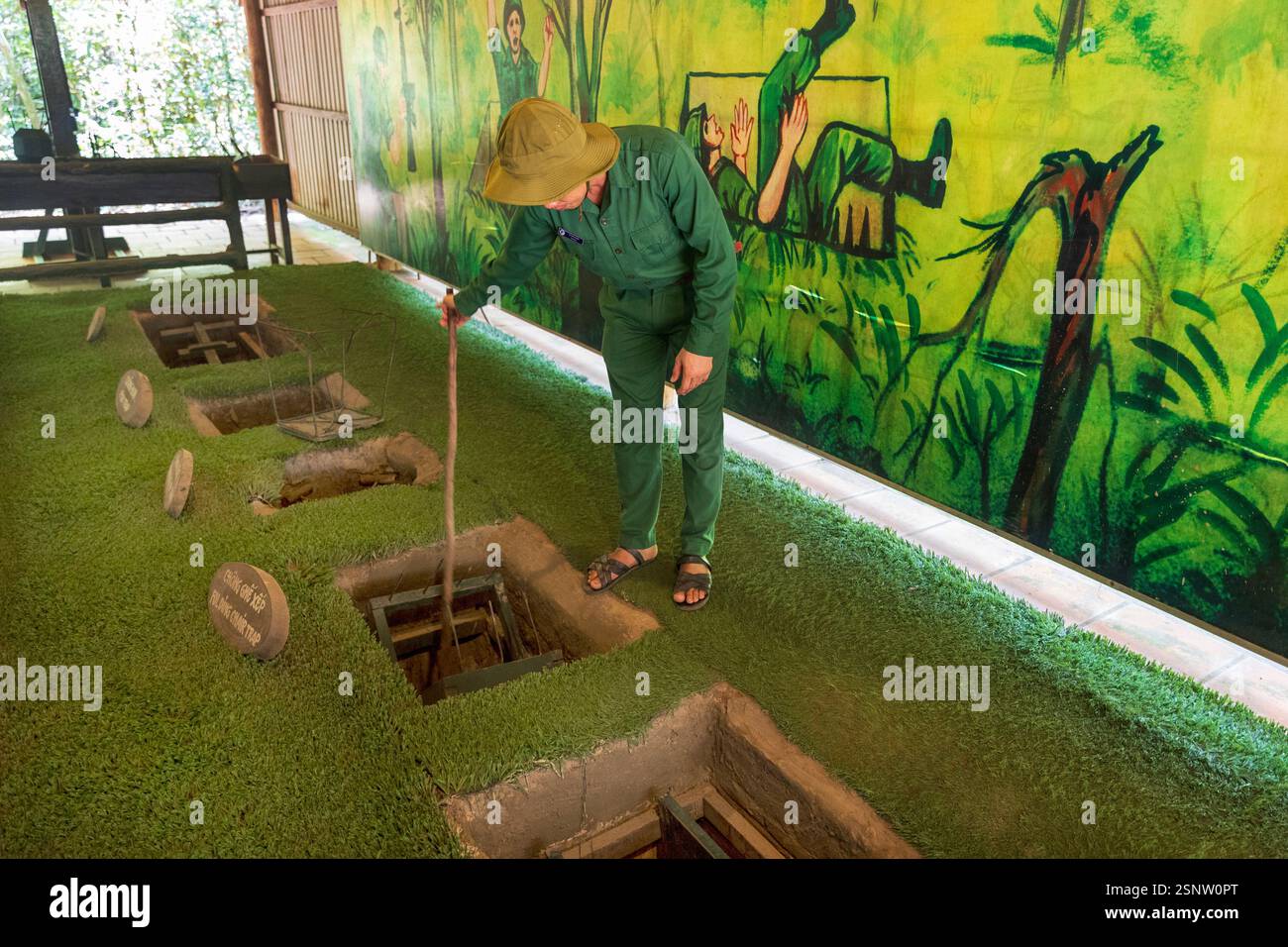 A guide demonstrates the various man traps at Cu Chi Tunnels, Ho Chi ...