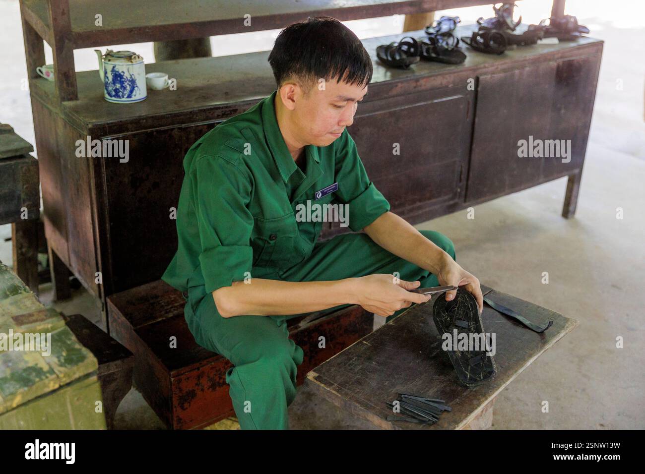 A guide demonstrates shoe making at Cu Chi Tunnels, Ho Chi Minh ...
