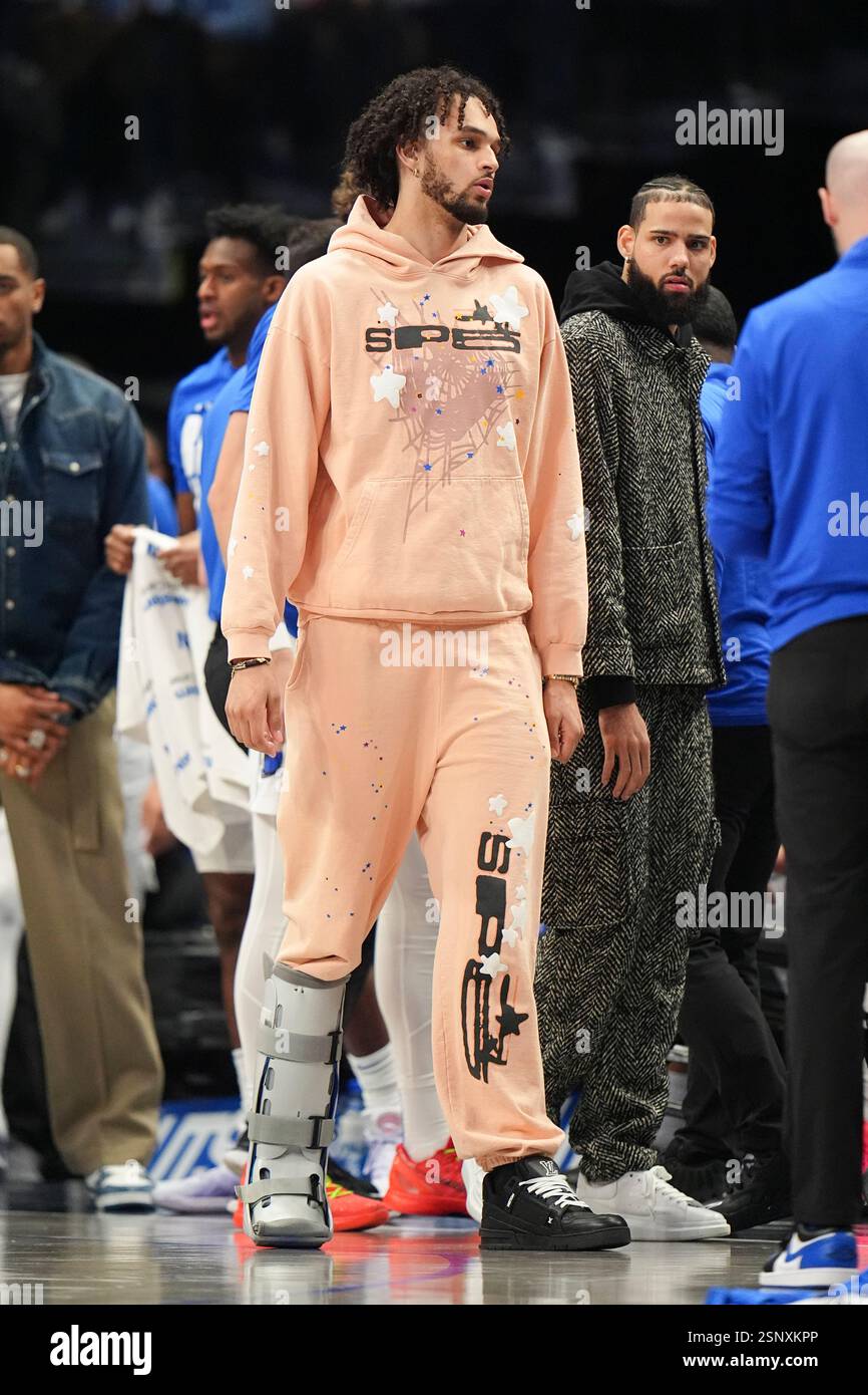 Dallas Mavericks center Dereck Lively II walks with a boot on the court ...