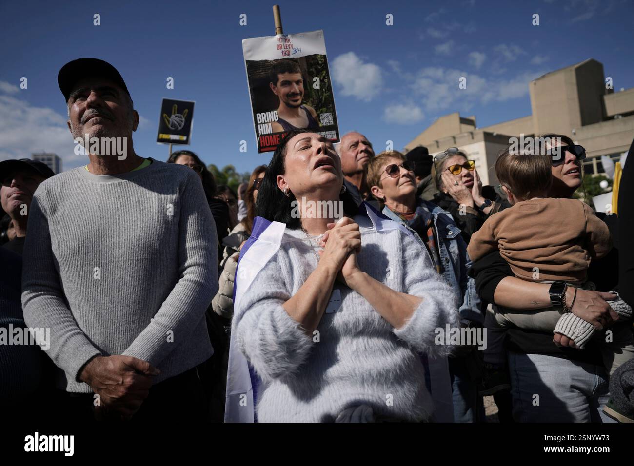 People holding posters with photos of Israelis hostages Eli Sharabi, Or ...