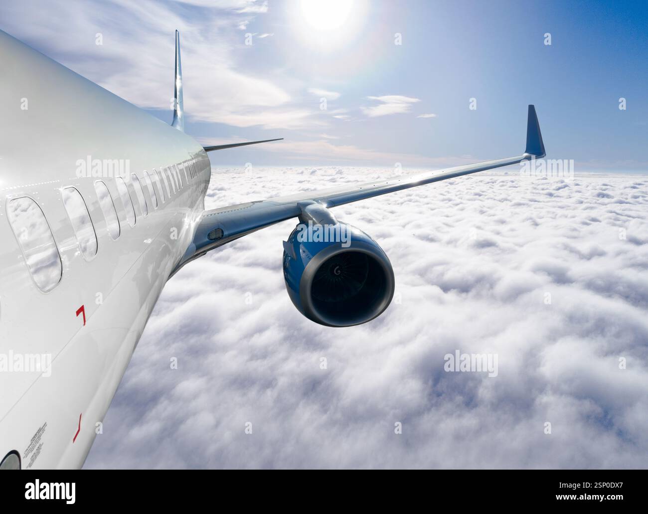 Passengers commercial airplane flying above clouds in sun light. Flying ...