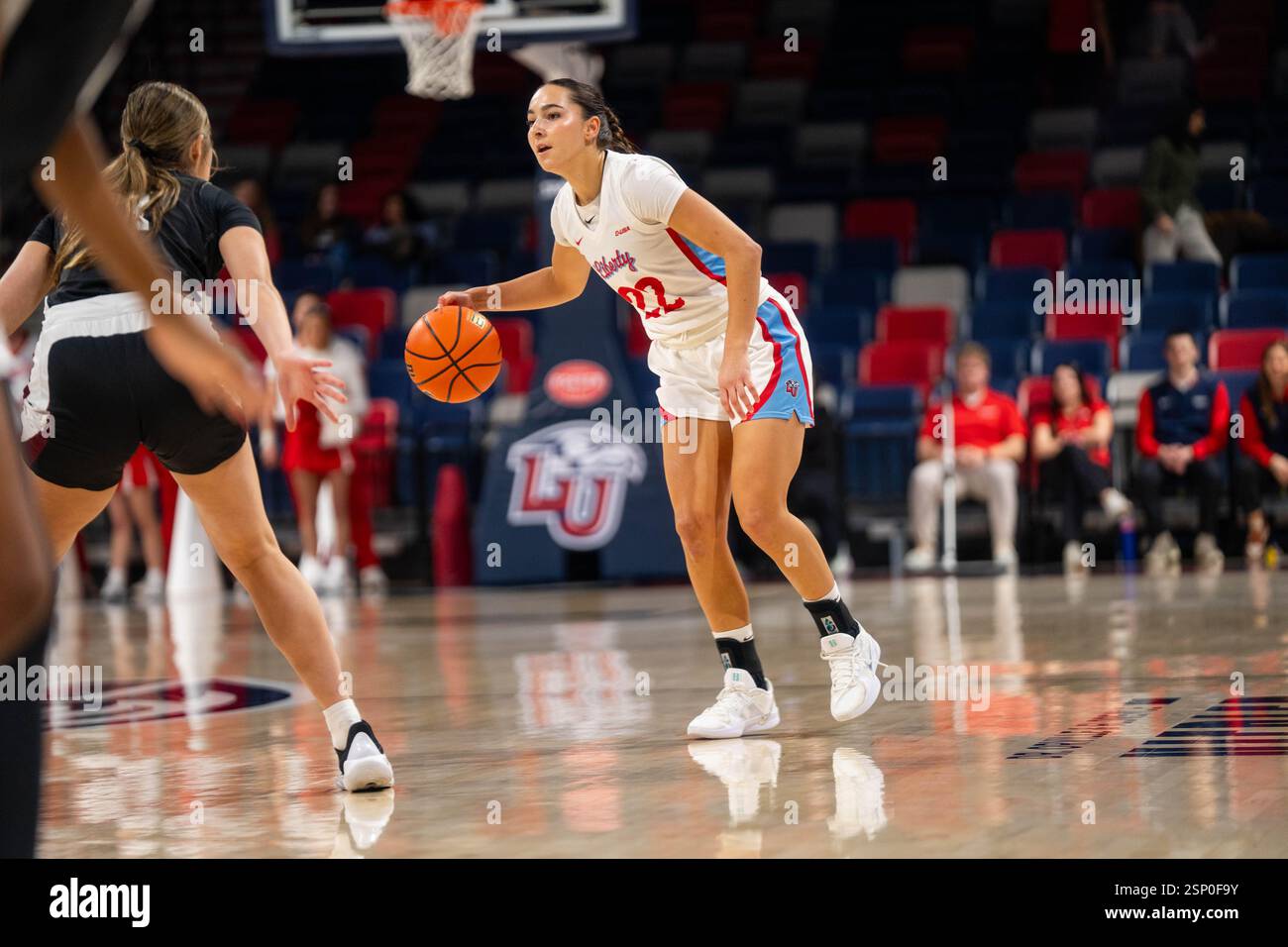 Anna Badosa #22 of the Liberty Lady Flames looks for an open teammate ...