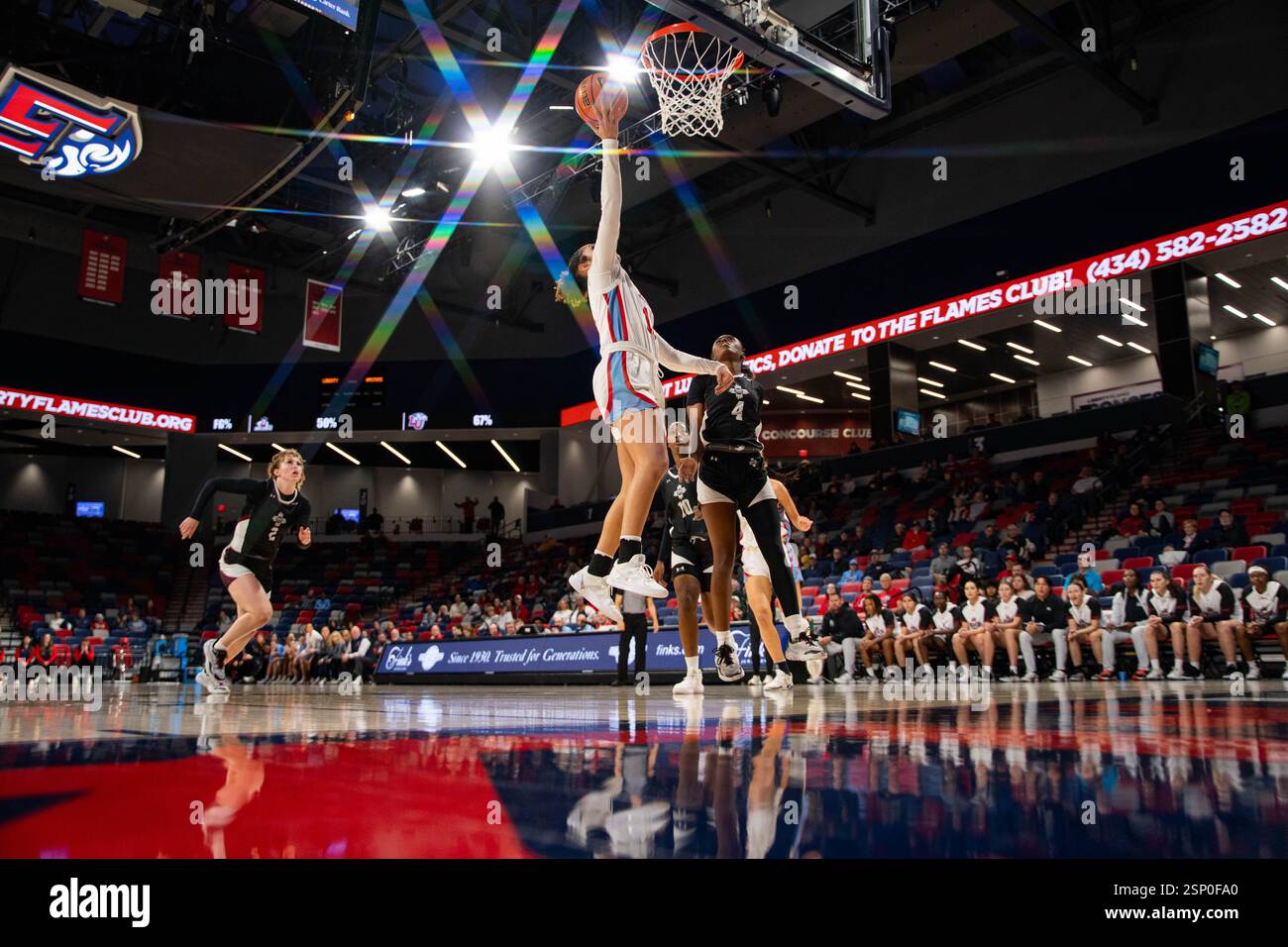 Asia Boone #12 of the Liberty Lady Flames goes to the basket against ...