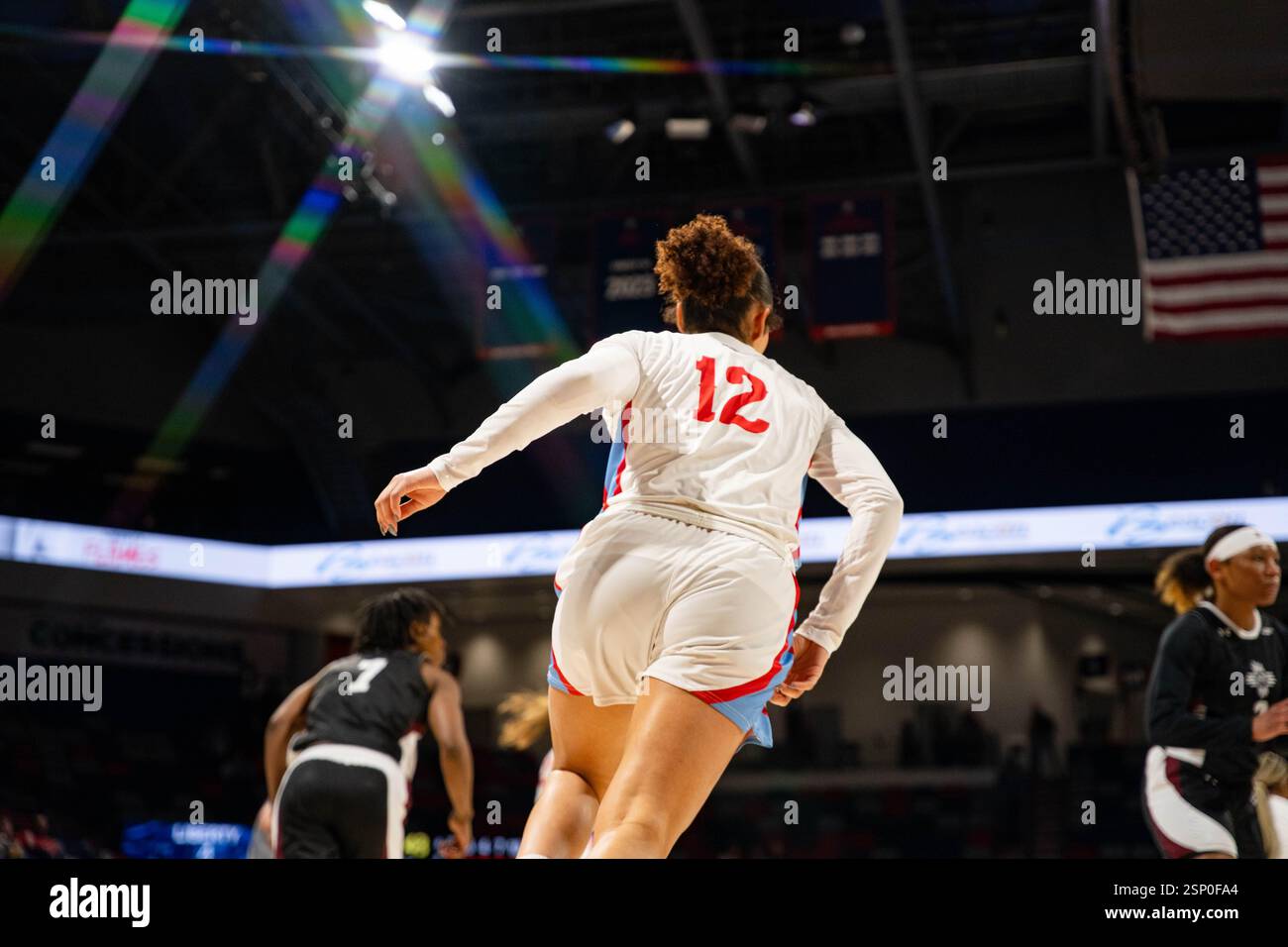 Asia Boone #12 of the Liberty Lady Flames runs back to defense after ...