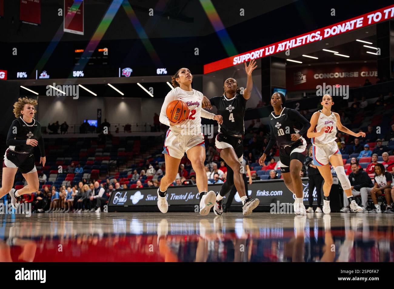 Asia Boone #12 of the Liberty Lady Flames goes to the basket against ...