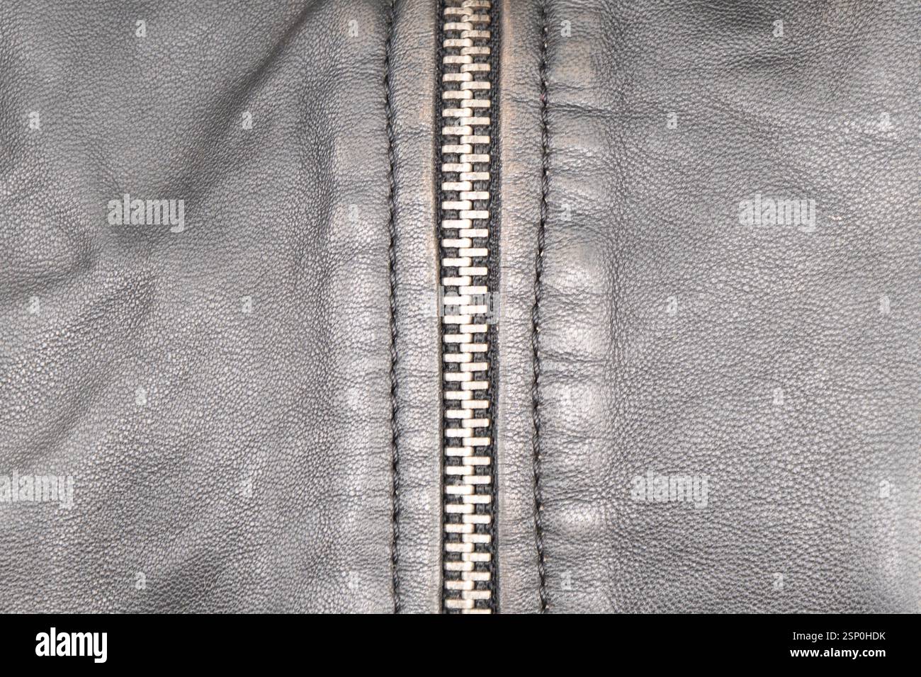 Macro shot of zipper on black leather texture background with stitching ...