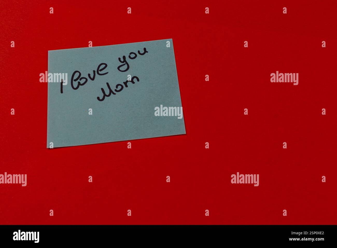 A handwritten note on a vibrant red background reads I love you Mom ...
