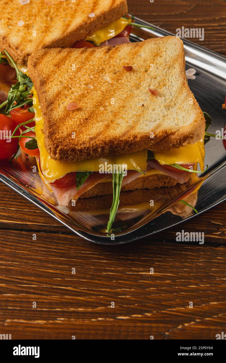 Enjoy a mouthwatering grilled sandwich featuring layers of ham, spinach ...