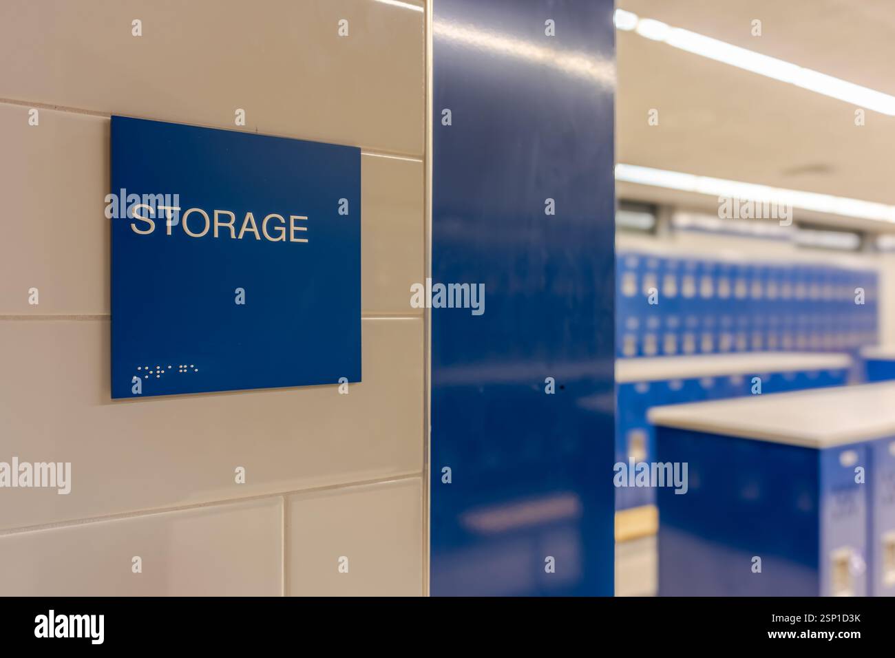 Storage blue sign mounted on exterior blue wall, next to a open doorway ...