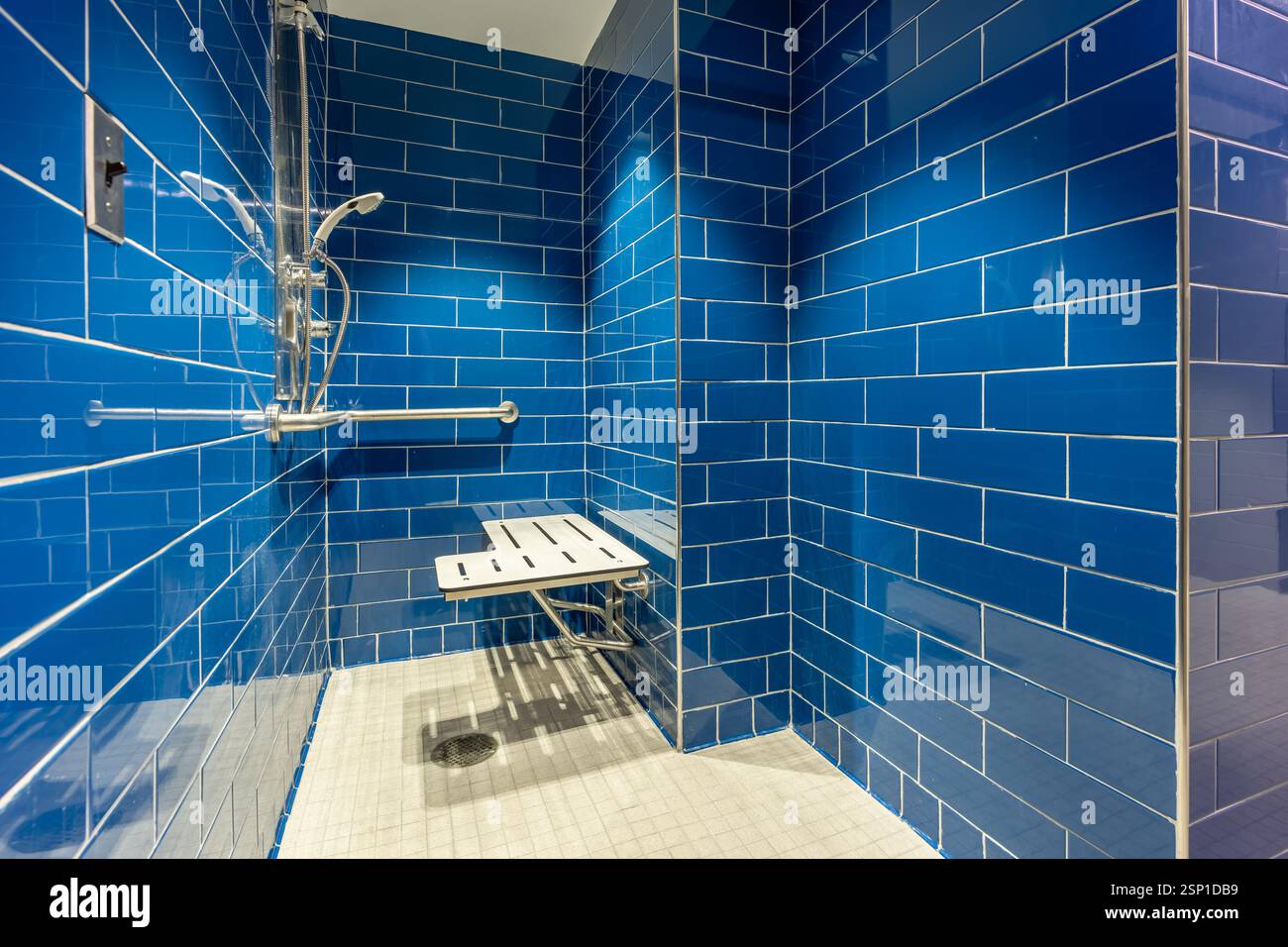 New single, private, gym locker room shower with blue tile wall, bench ...