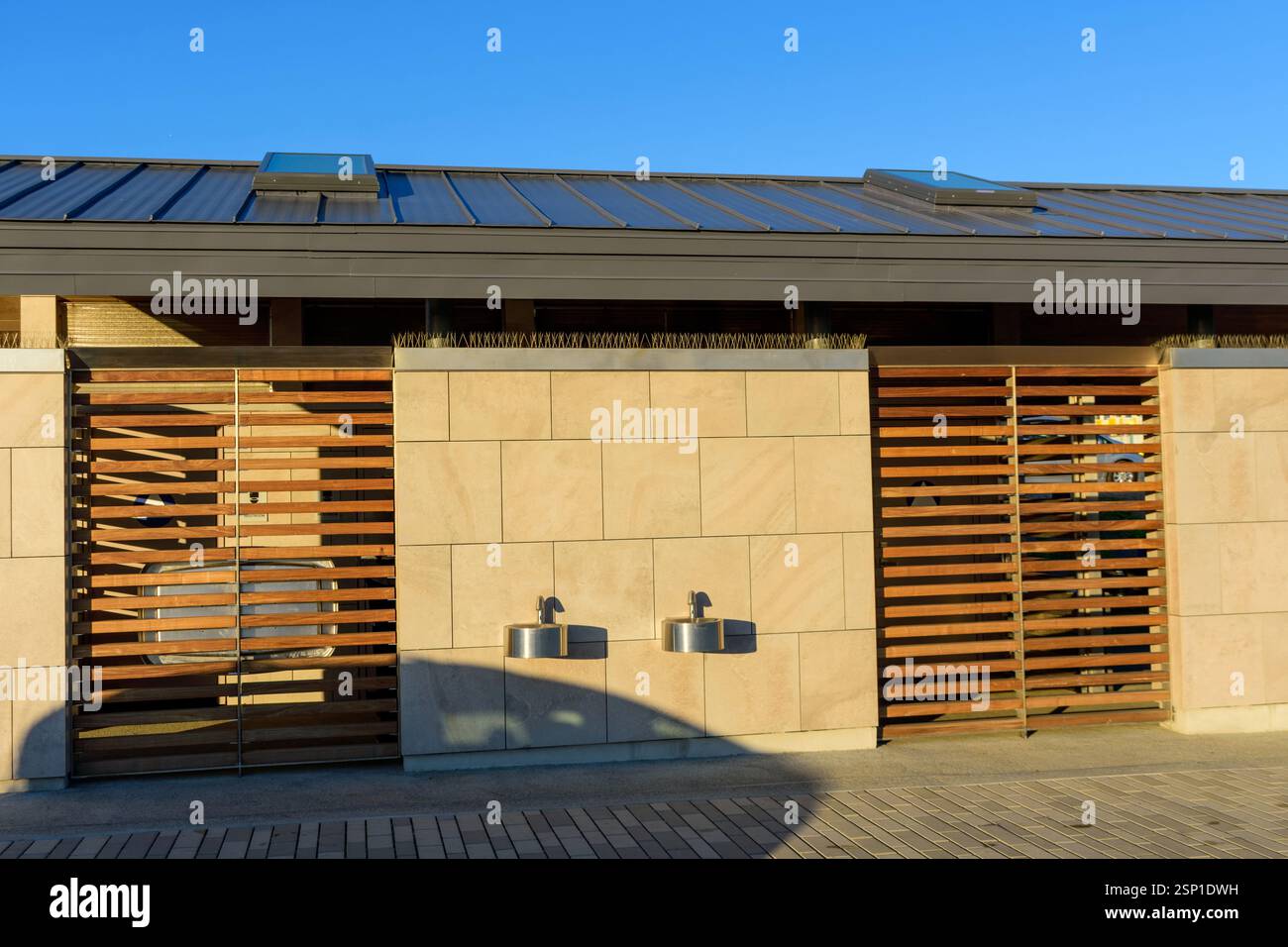 Exterior view of modern restroom facility at park, featuring sleek ...