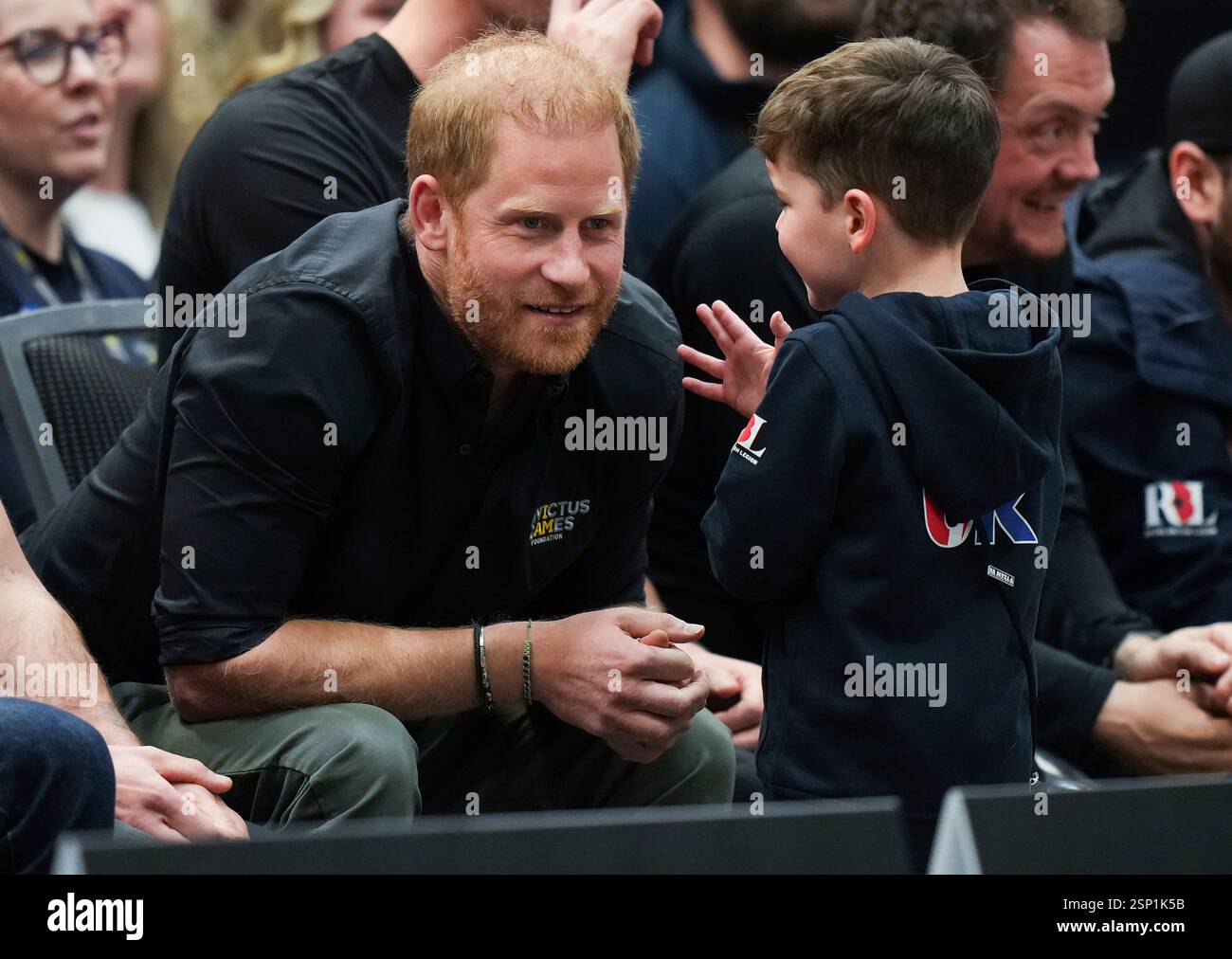 Britain's Prince Harry, the Duke of Sussex, listens to a young boy ...