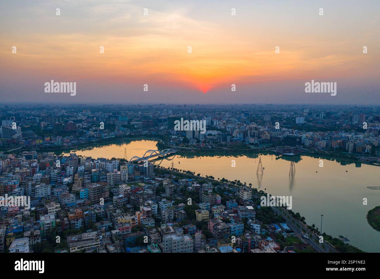 A stunning aerial view of Dhaka’s Hatirjheel area bathed in the warm hues of sunset. Dhaka ...