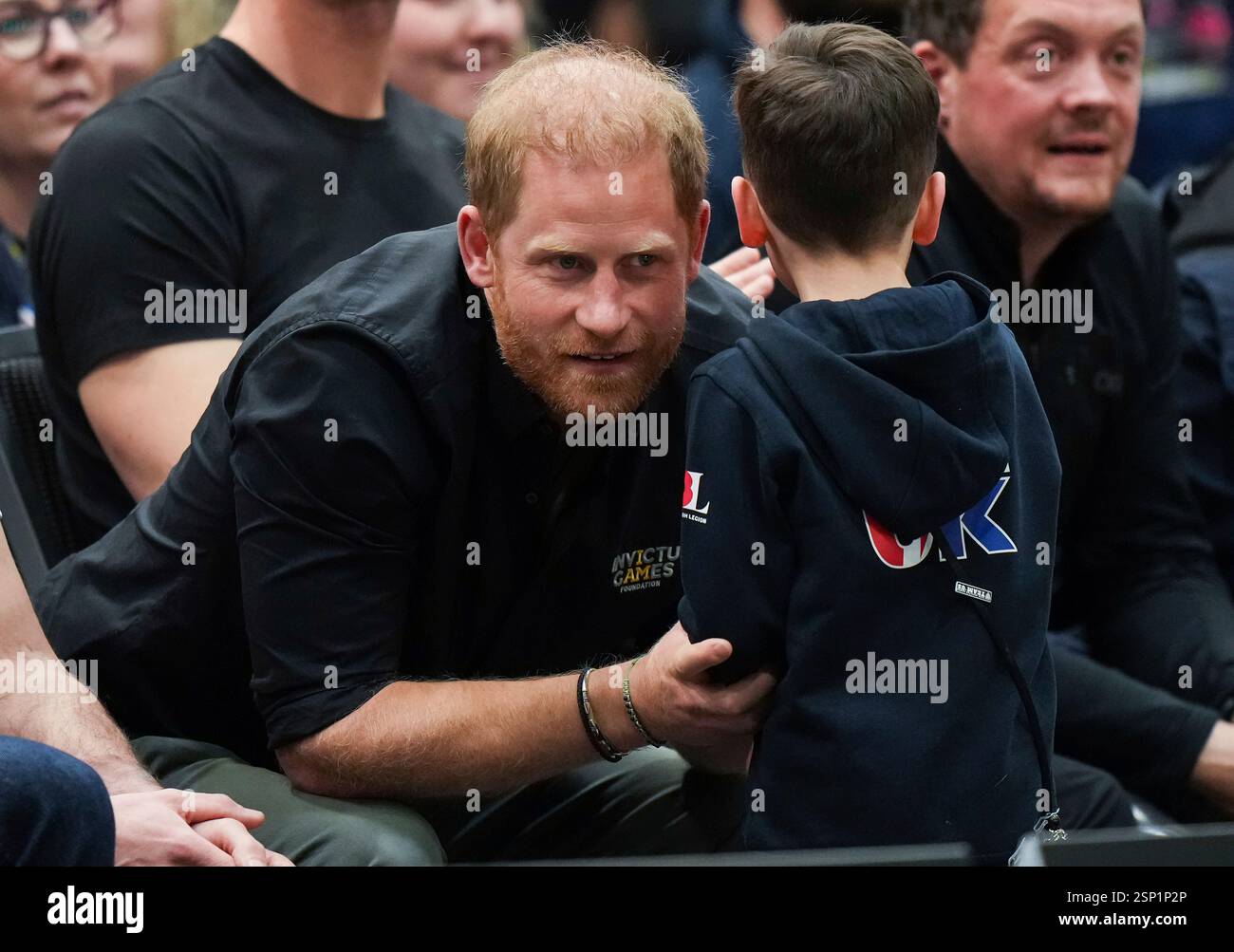 Britain's Prince Harry, the Duke of Sussex, listens to a young boy ...