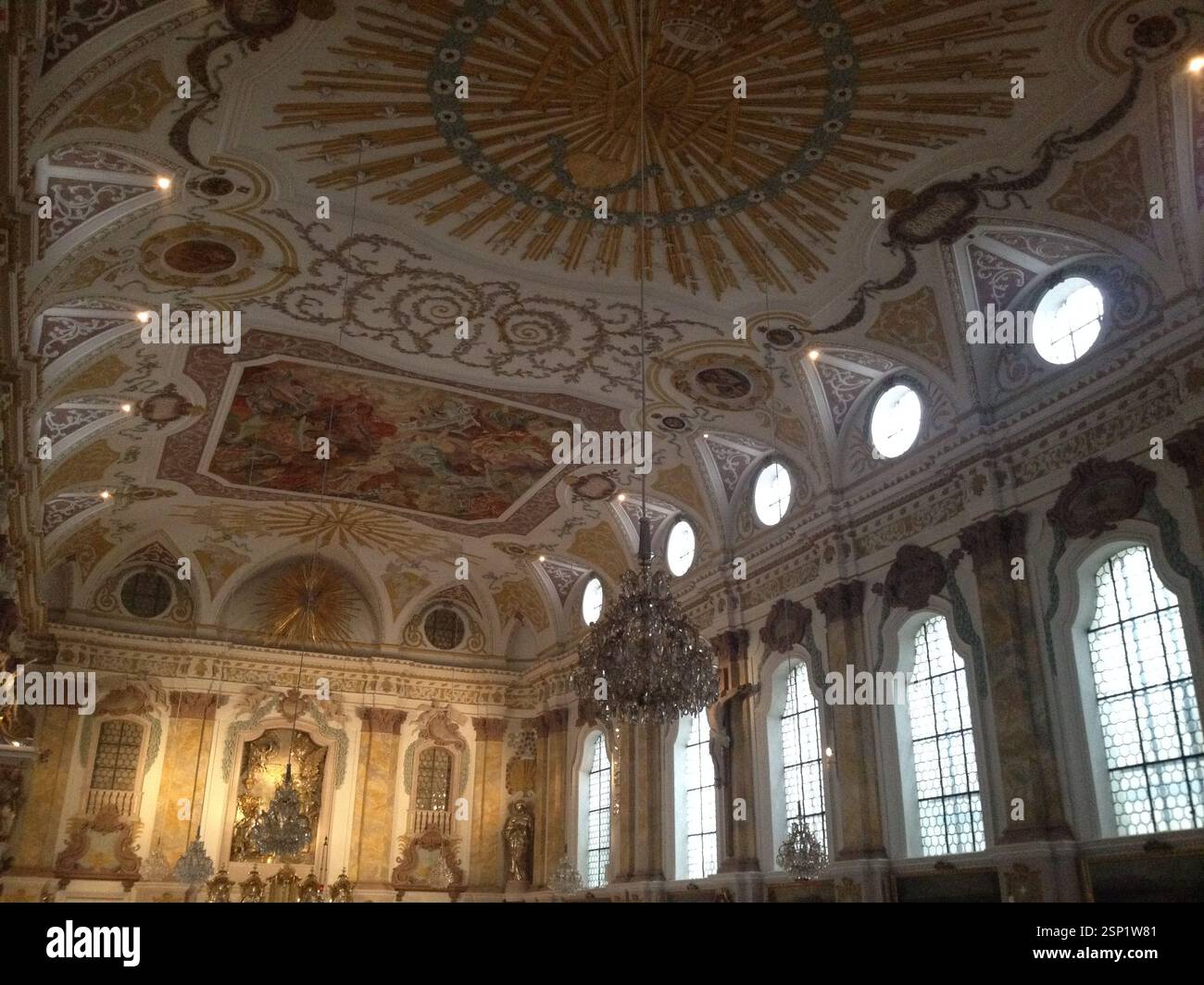 Ornate church interior, Germany, Munich. Painted ceiling and chandelier ...