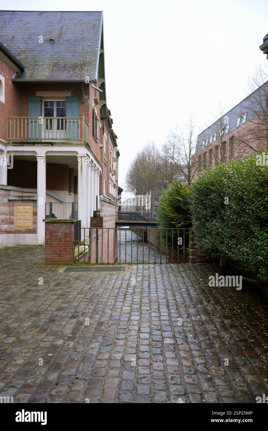 A cobblestone street in Amiens, France, featuring historic brick ...