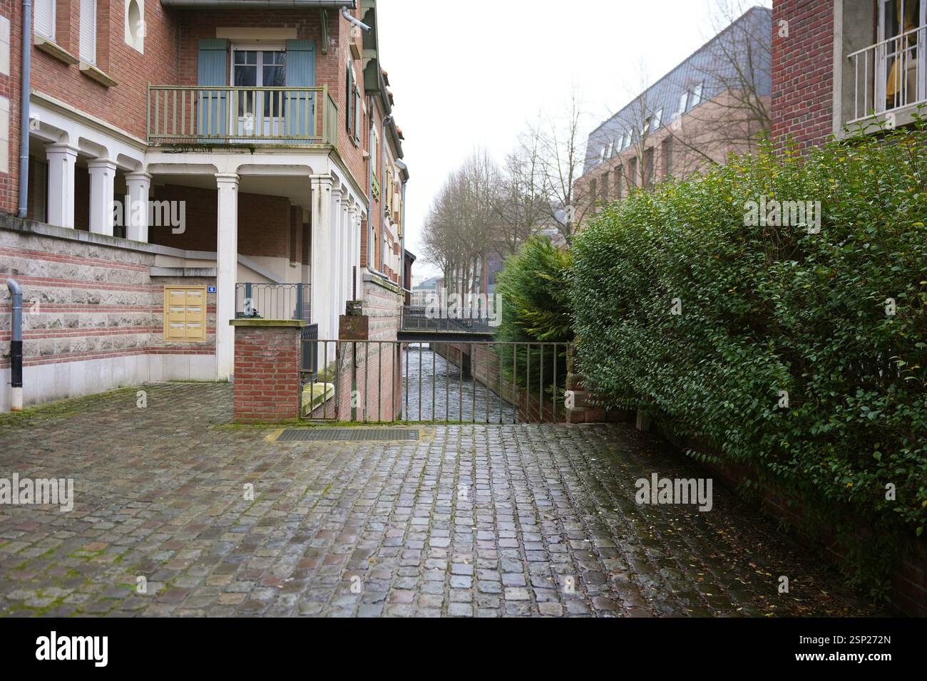 A cobblestone path in Amiens, France, bordered by historic brick ...