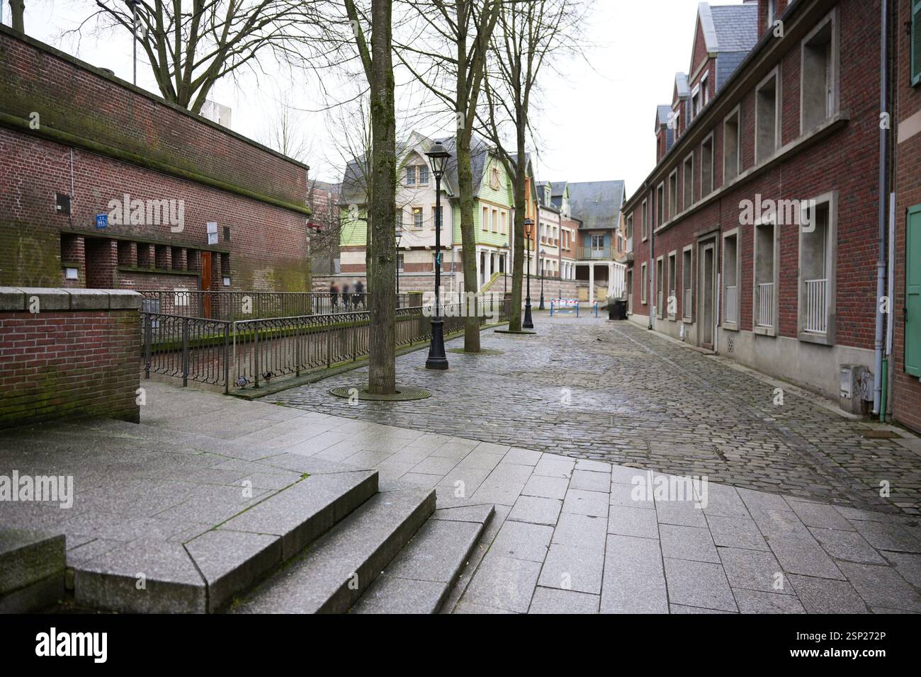 A peaceful cobblestone street in Amiens, France, surrounded by brick ...