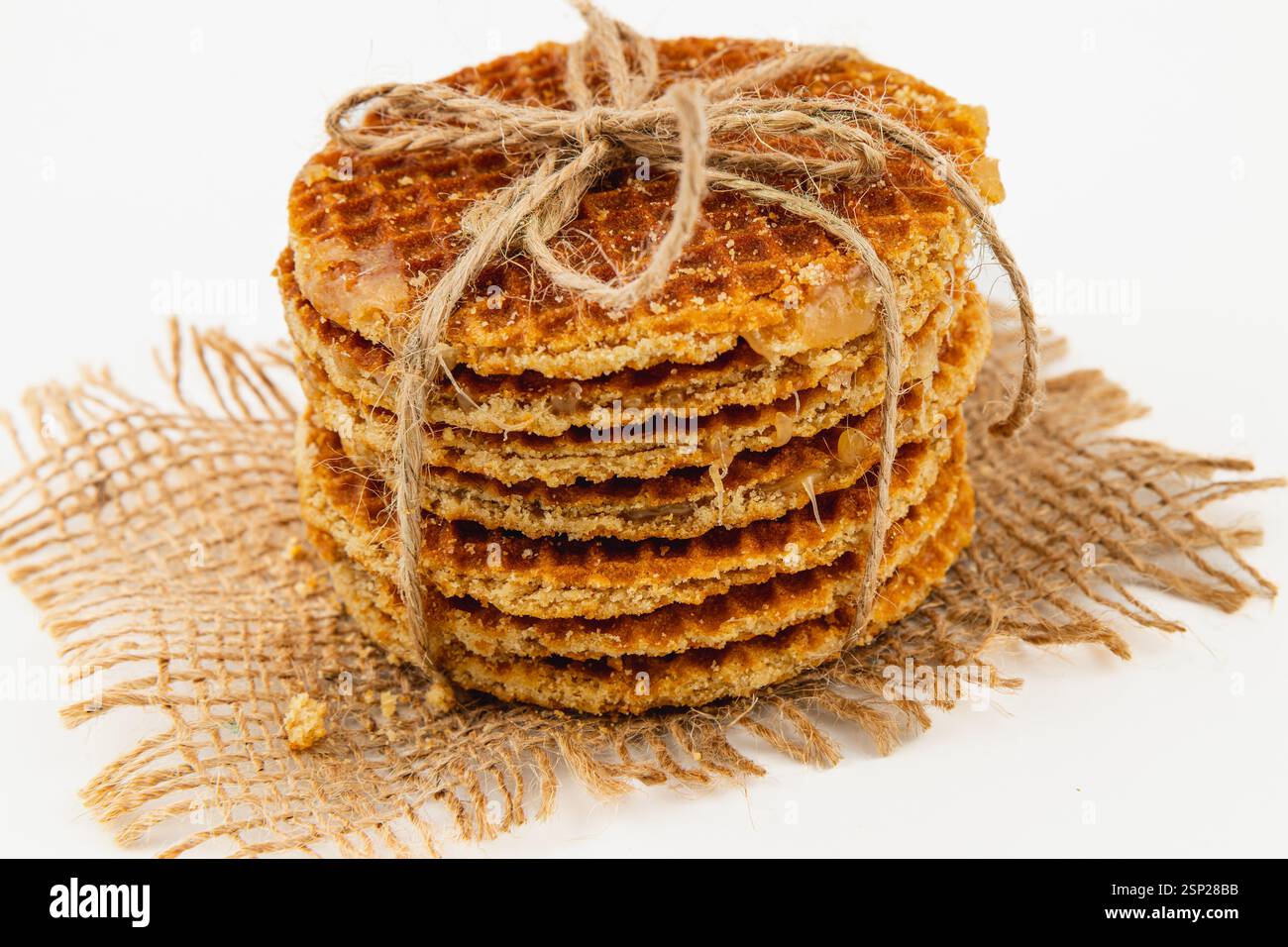 Stacked caramel waffles are beautifully tied with twine, showcasing a ...