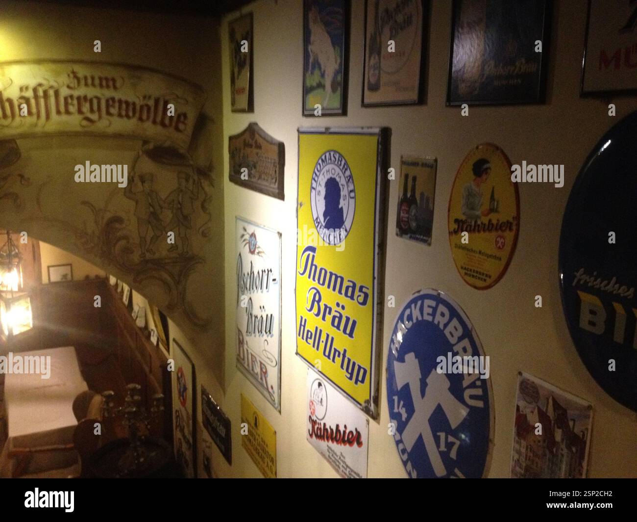 Wall adorned with vintage beer advertisements and signs. Germany ...