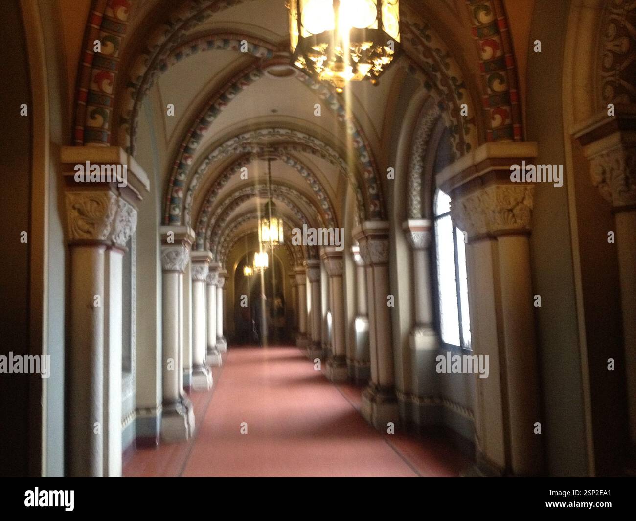 Long, arched corridor in Germany, Munich. Ornate columns and decorative ...