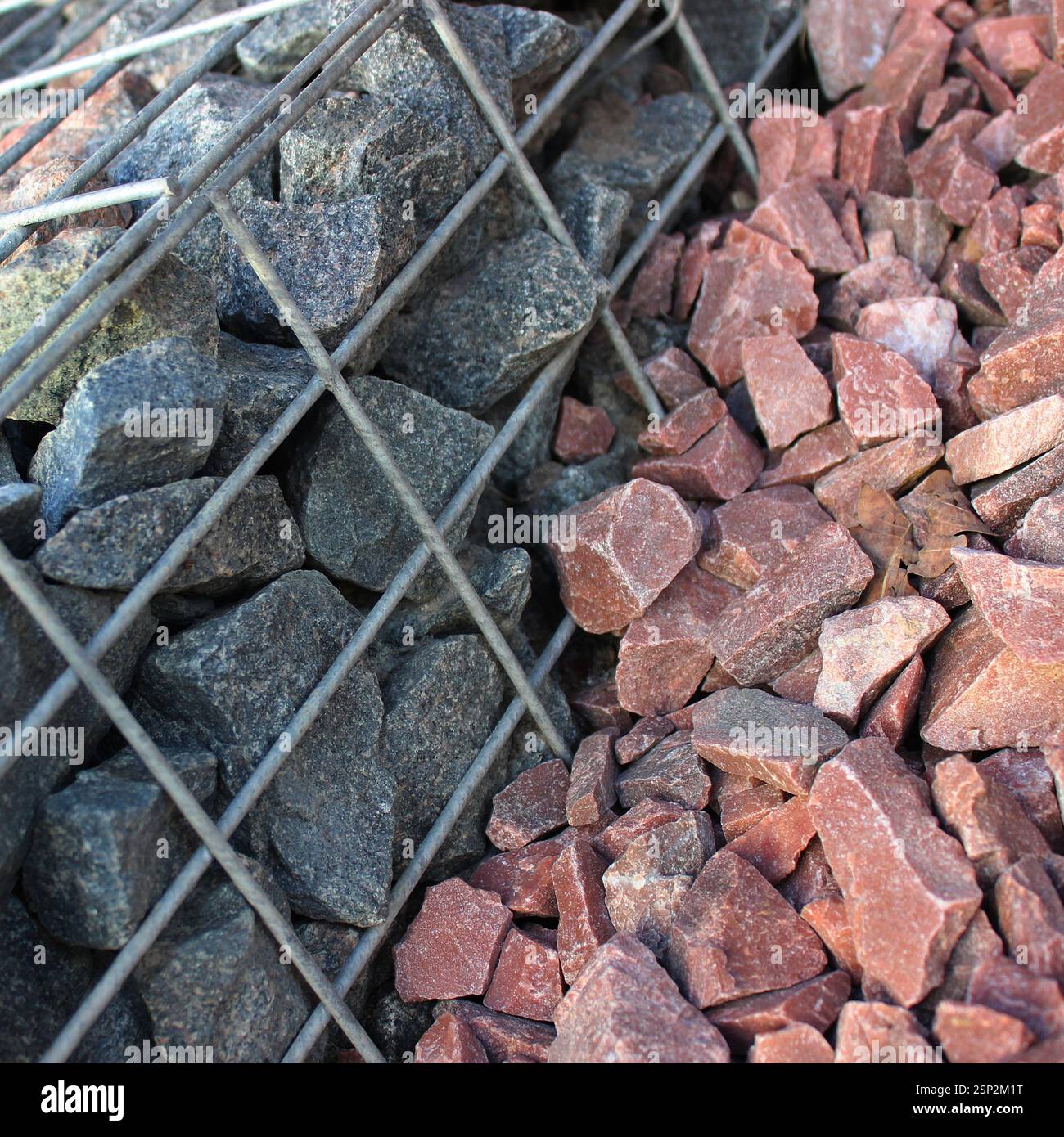 Colored crushed stones in the mesh fence and scattered around it ...