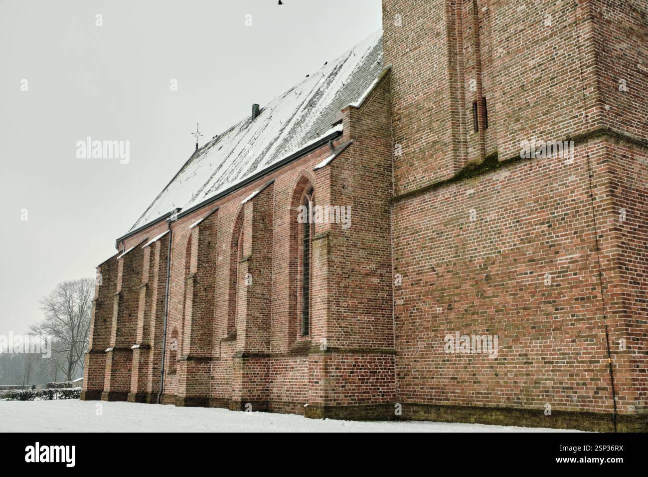A historic brick church with old Gothic windows in Rolde, Netherlands ...