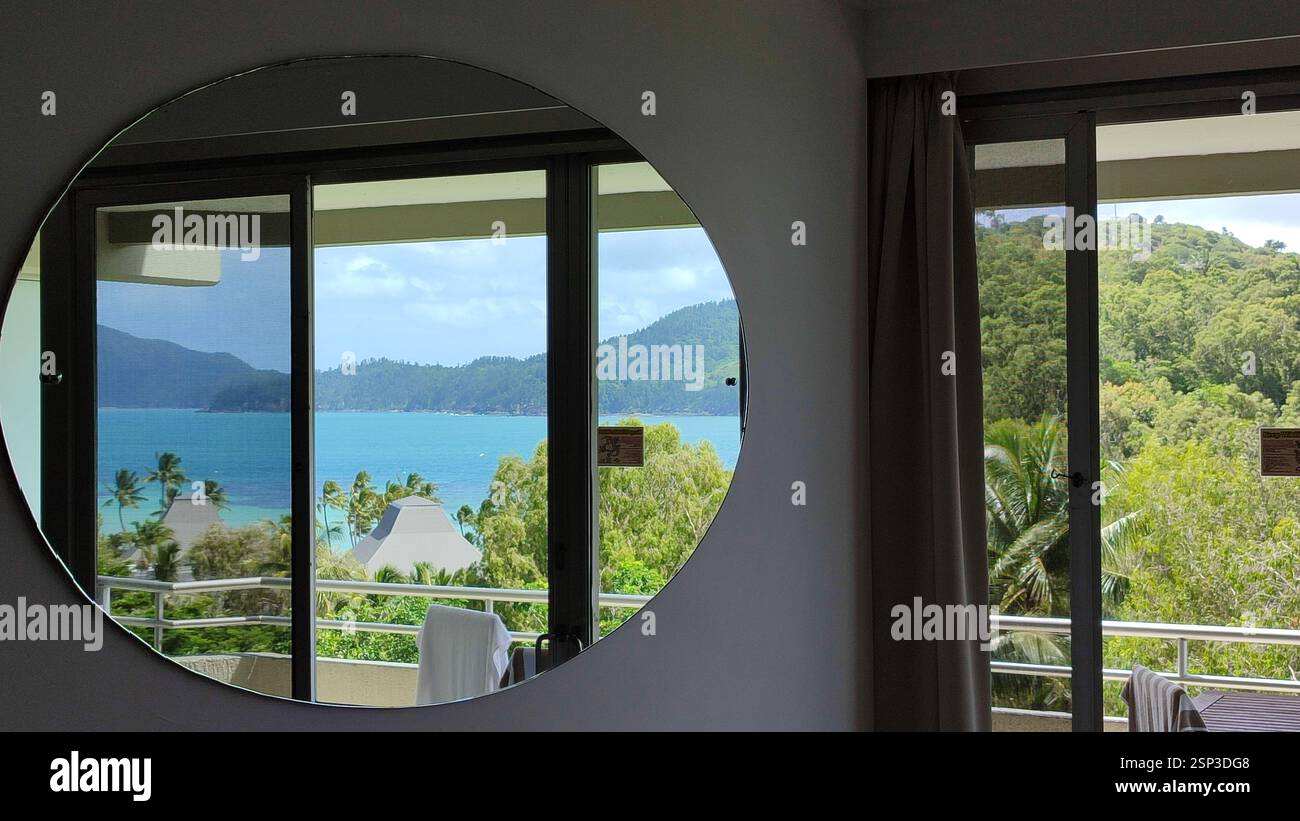 Hamilton Island view: turquoise water reflects in a window, creating a ...
