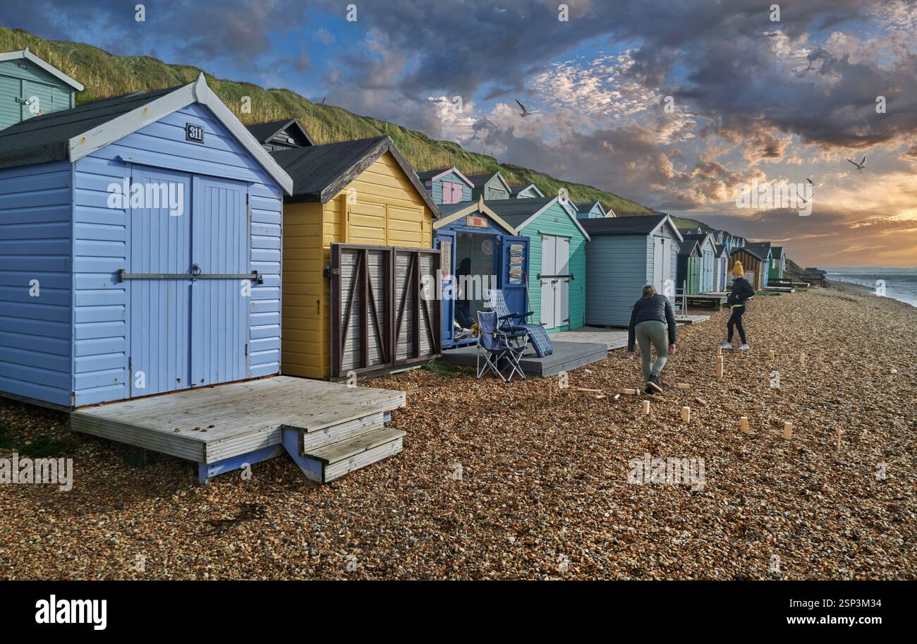 Traditional wooden painted colourful painted beach huts on the shingle ...