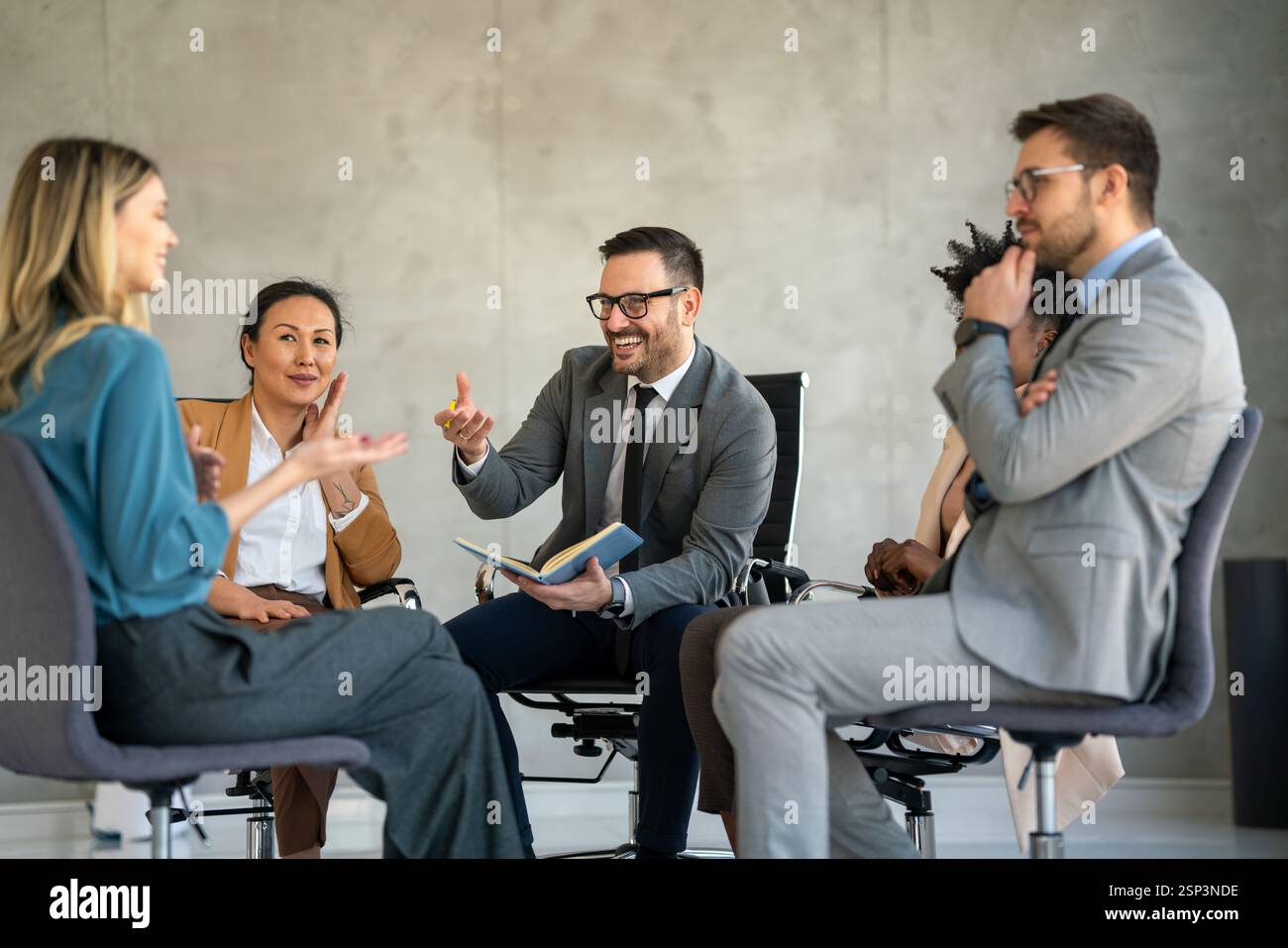Group therapy. Multiethnic professional people sitting together while ...