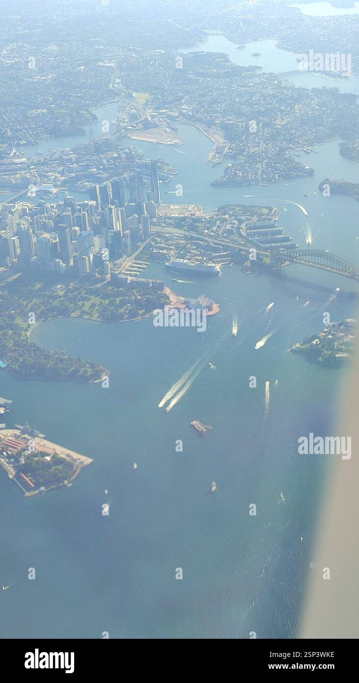 Sydney panorama: Ferries carve across turquoise waters beneath a ...