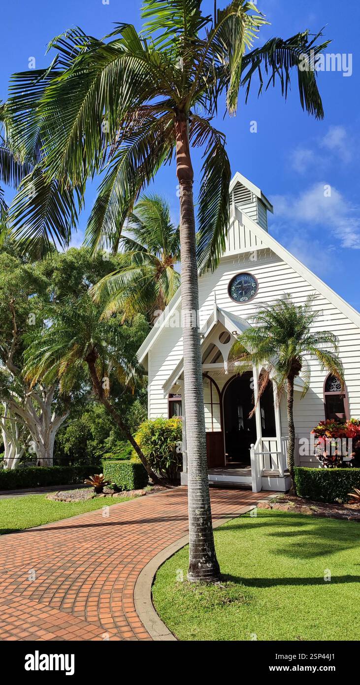 Tropical church with a palm tree stands on a peaceful island, idyllic ...