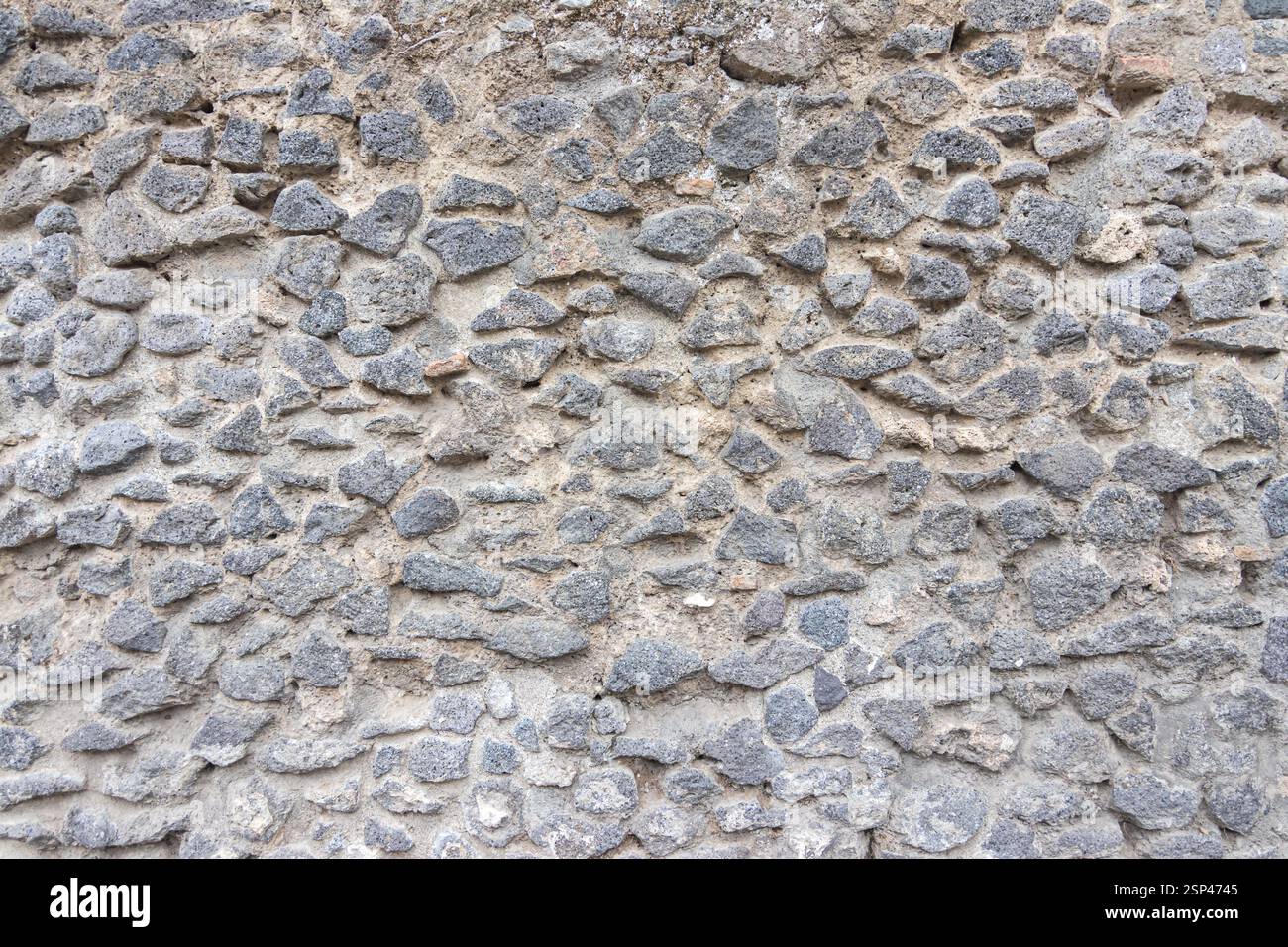 A detailed capture of a vintage and rustic stone wall, showcasing its ...