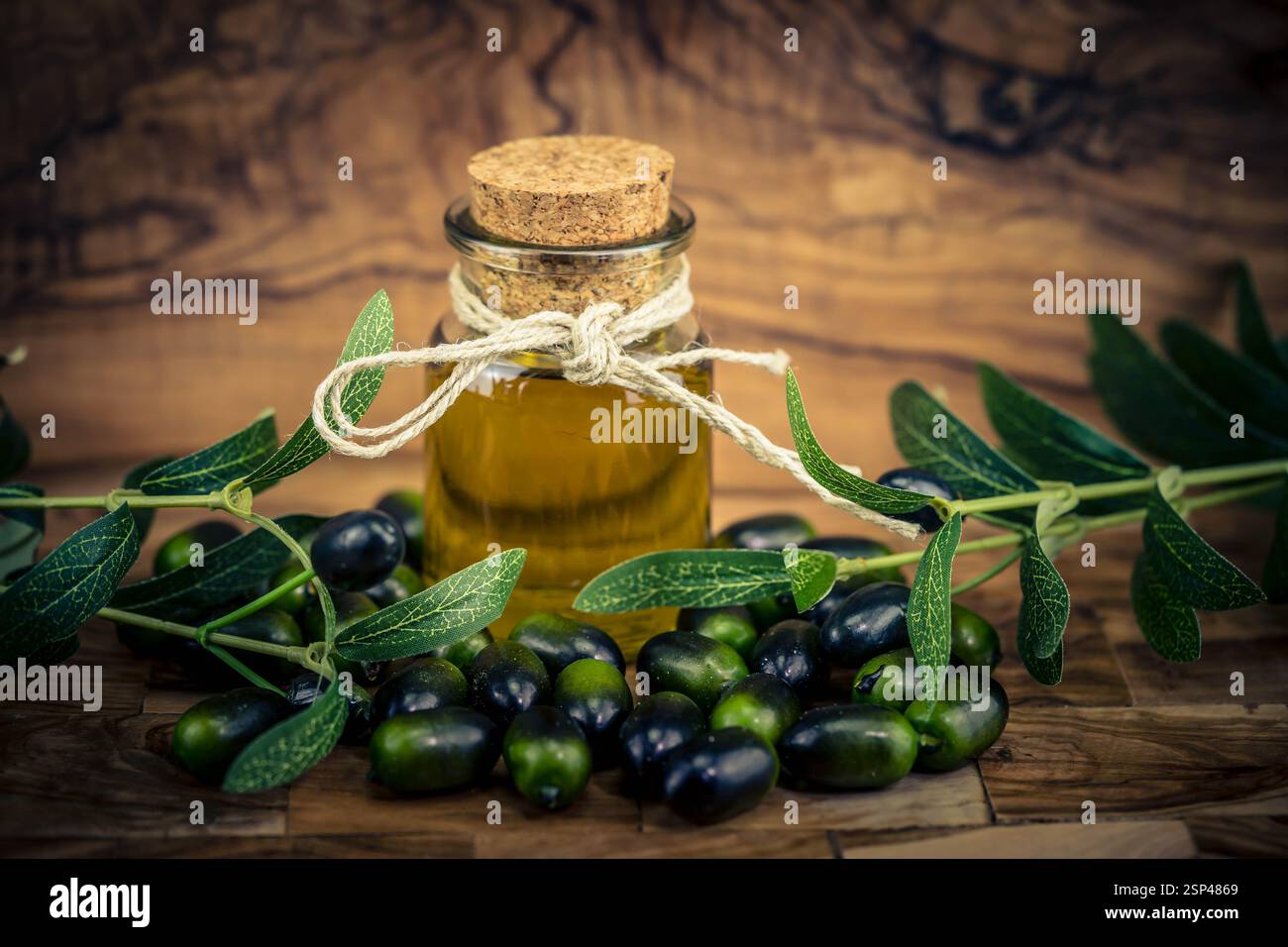 cold pressed extra virgin olive oil on olive wood Stock Photo - Alamy